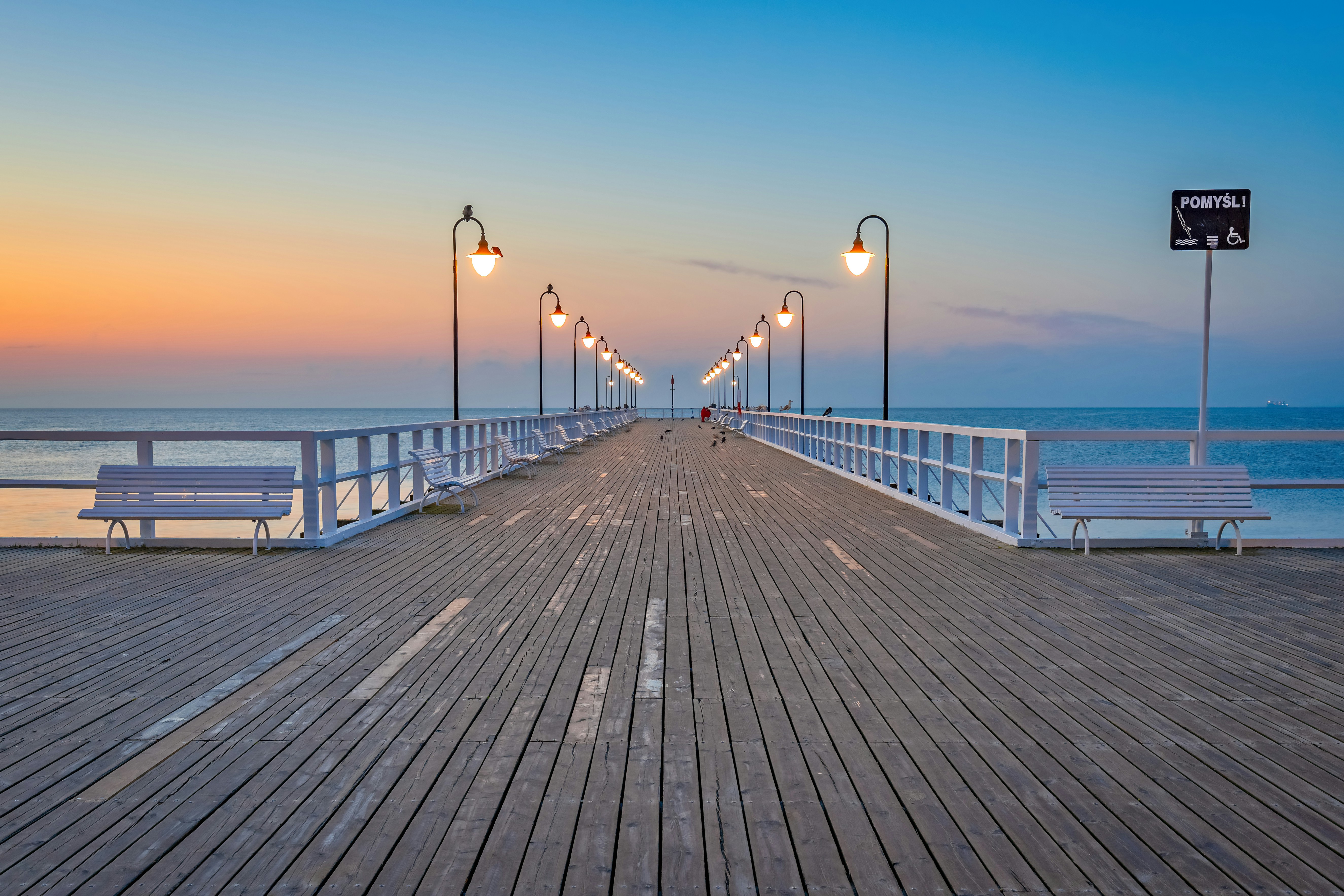 Sunset Pier: Lines of Light Recede Toward the Horizon