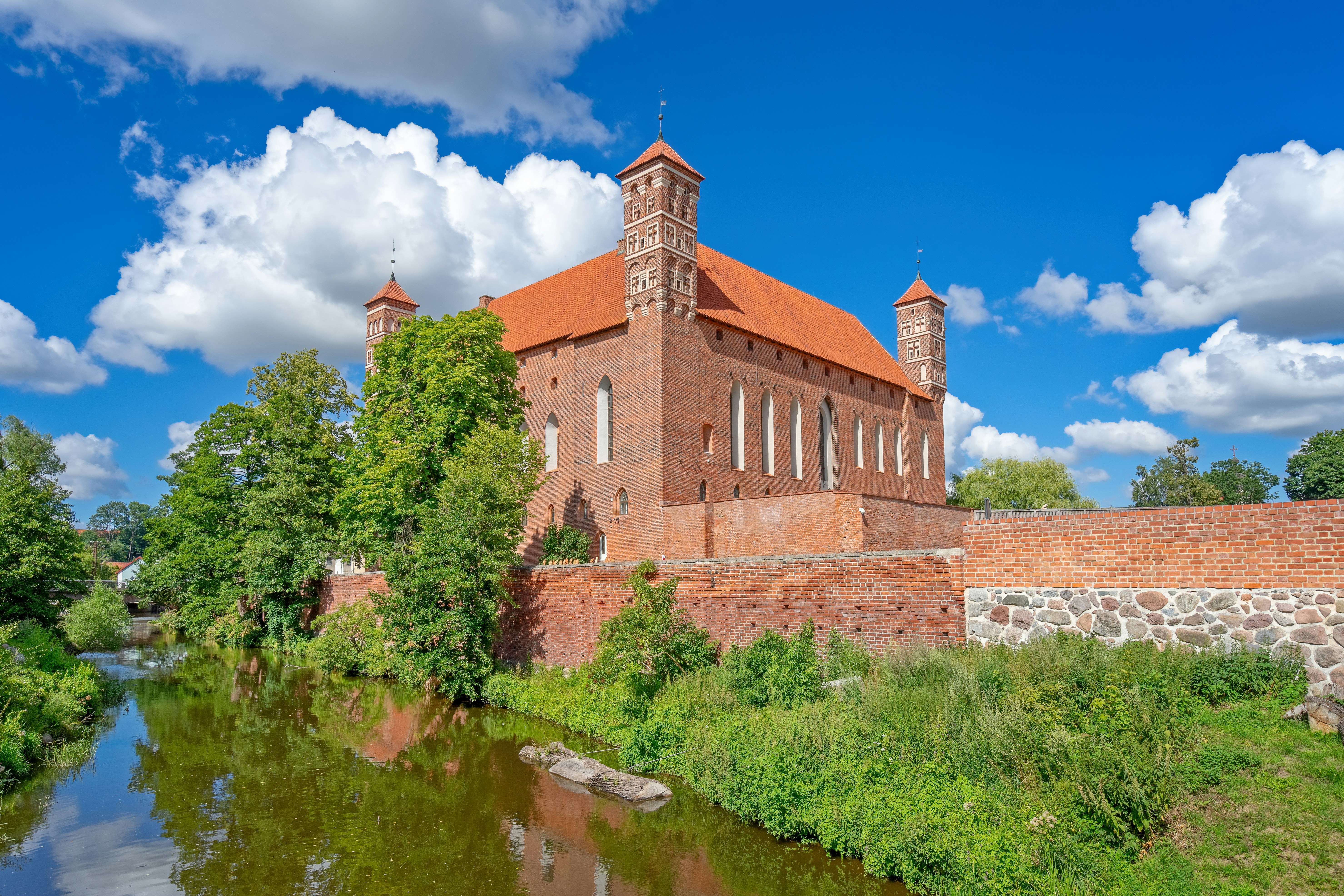 Red Brick Fortress Rising Over a Quiet River