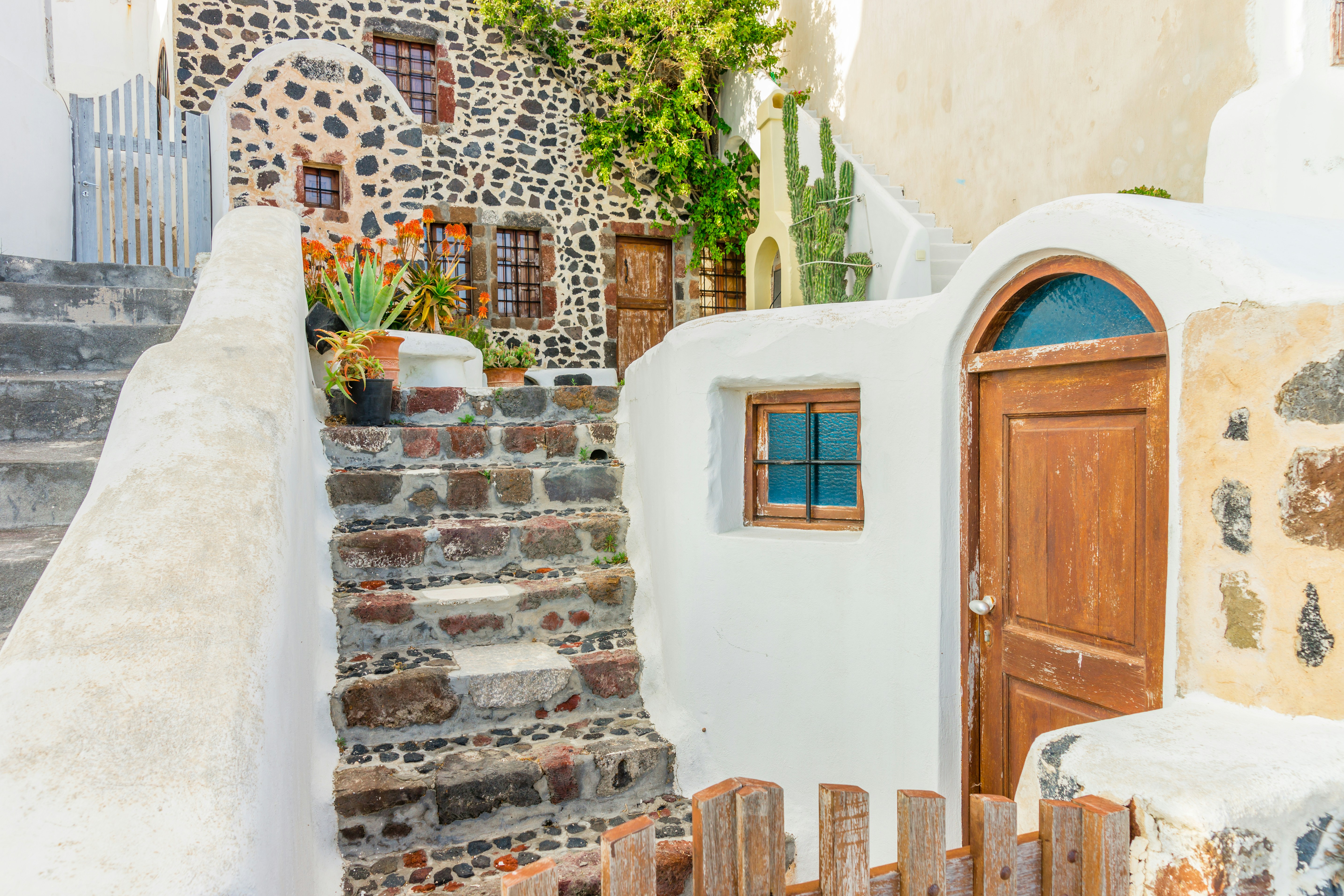 Sunlit Whitewash and Stone Steps in a Mediterranean Alley