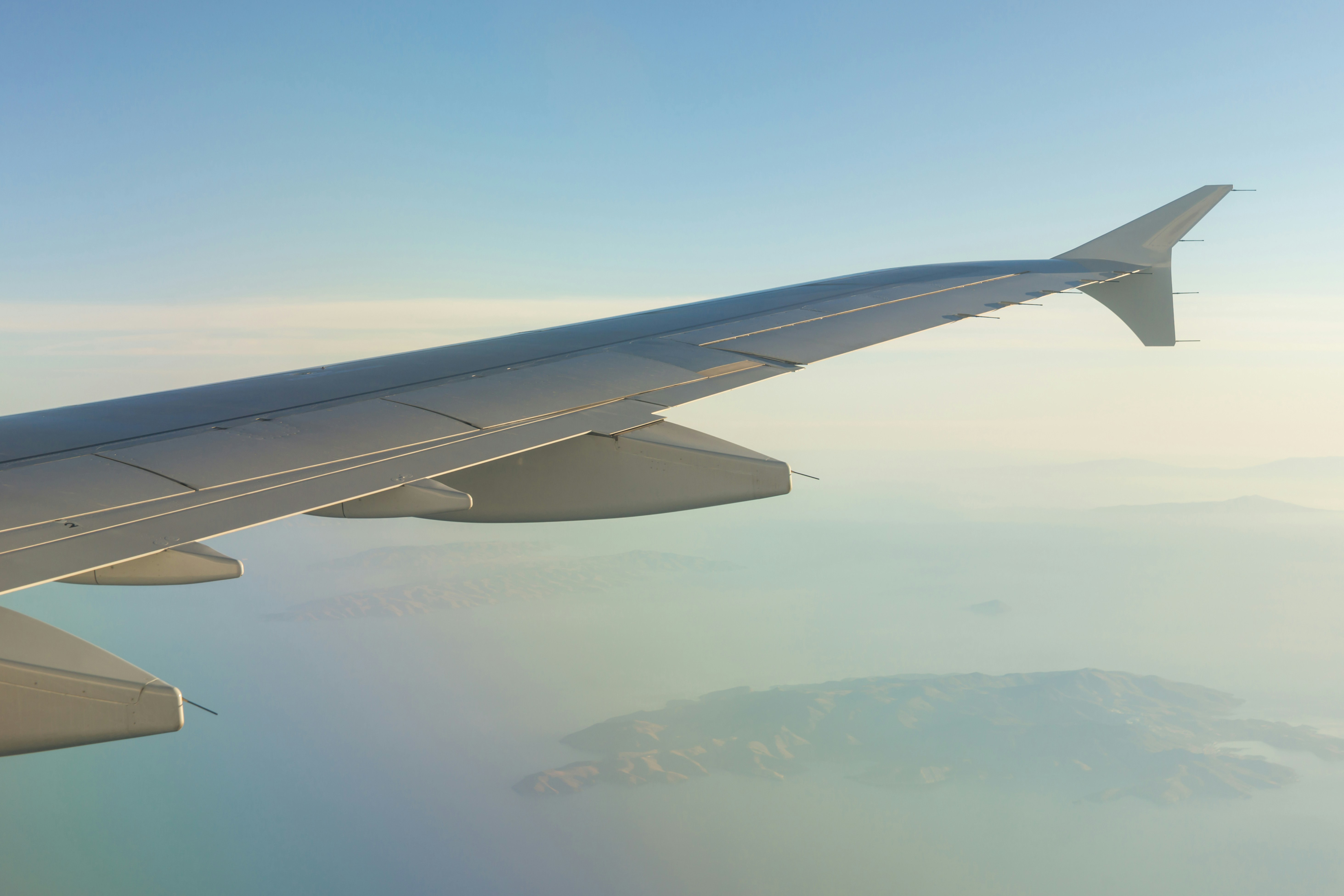 Winged Panorama: Coastal Clouds Beyond the Jet