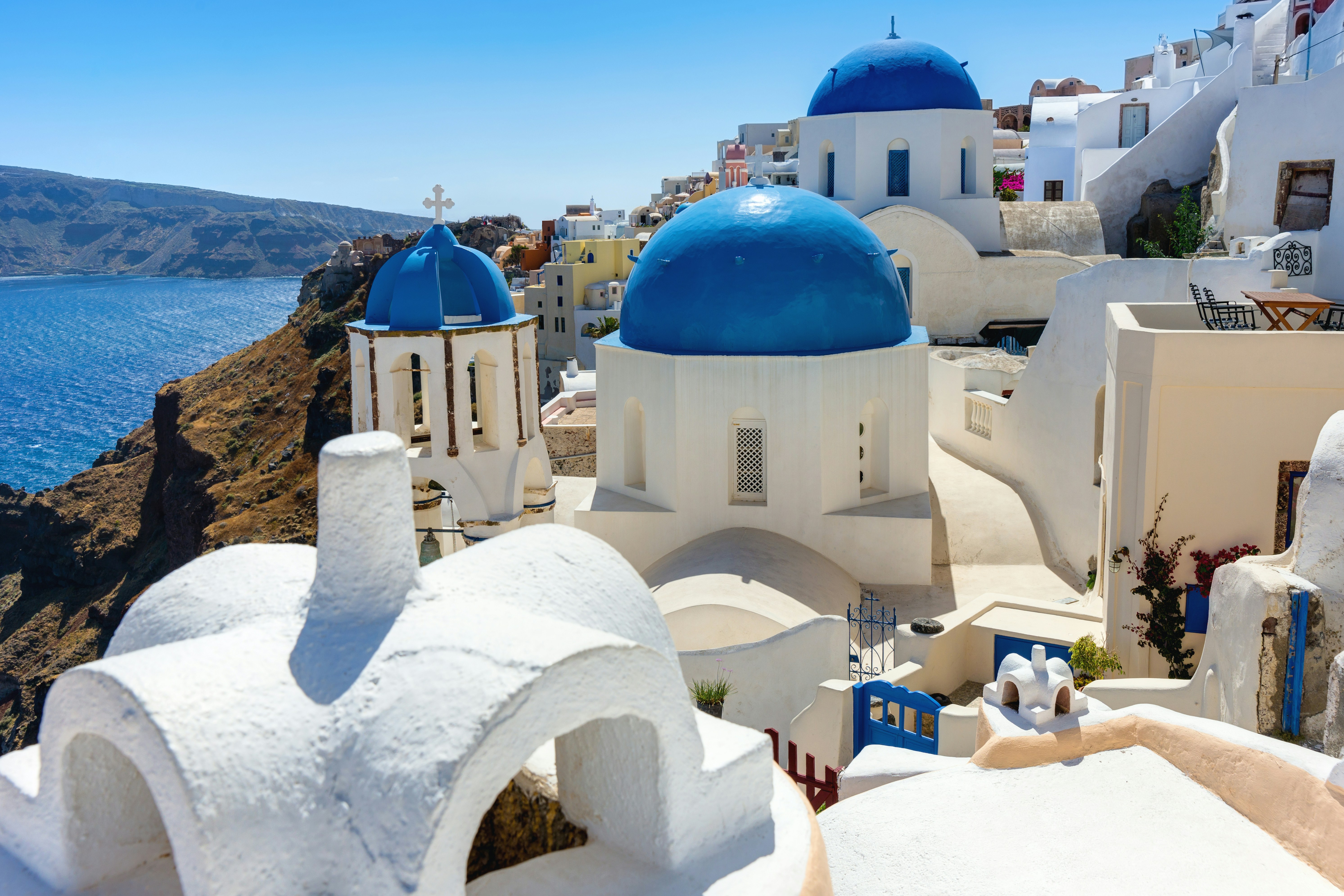 Azure Domes Over the Aegean White Village