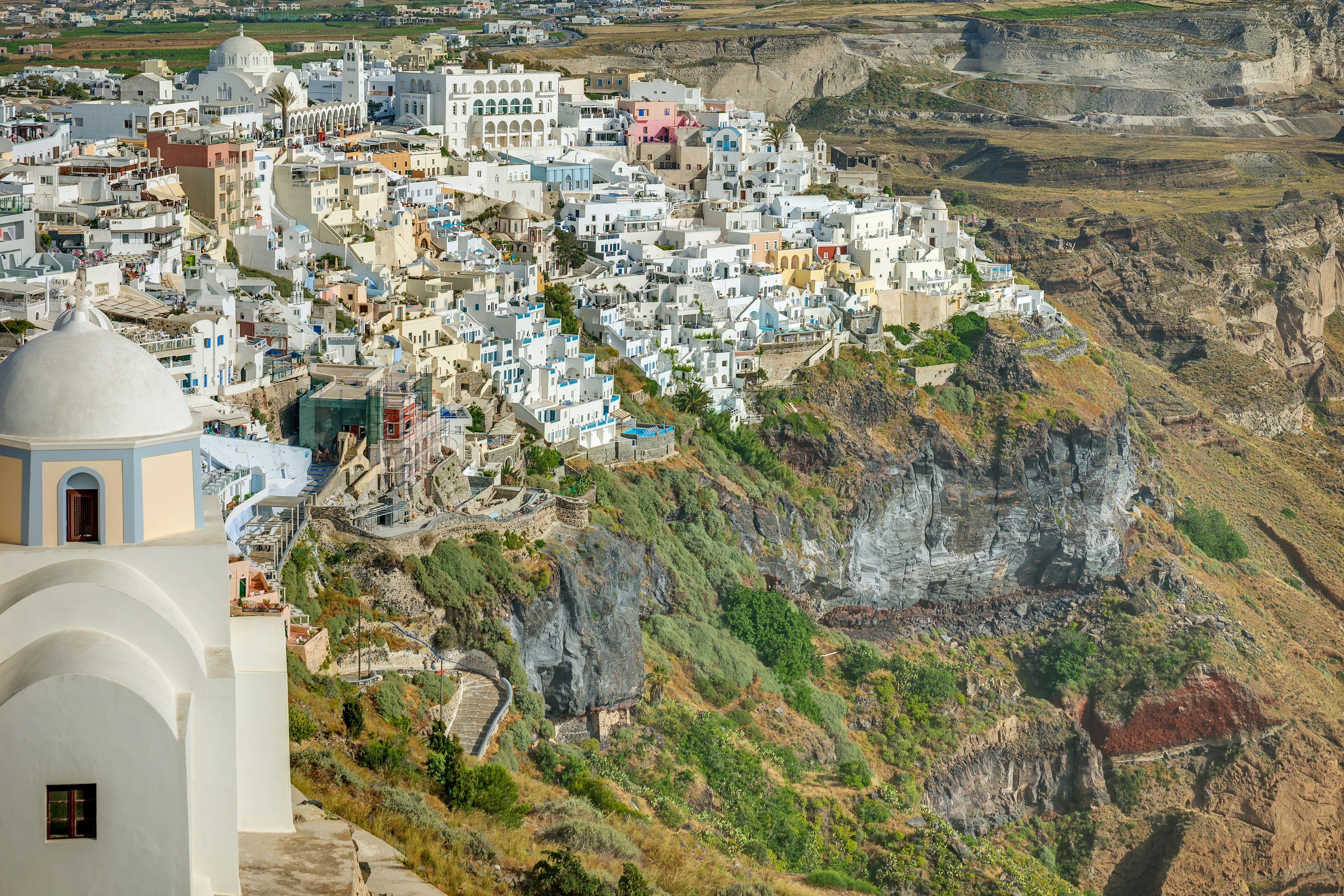 Whitewashed village clifftop stairway tracing the Santorini blaze of blues and caldera light