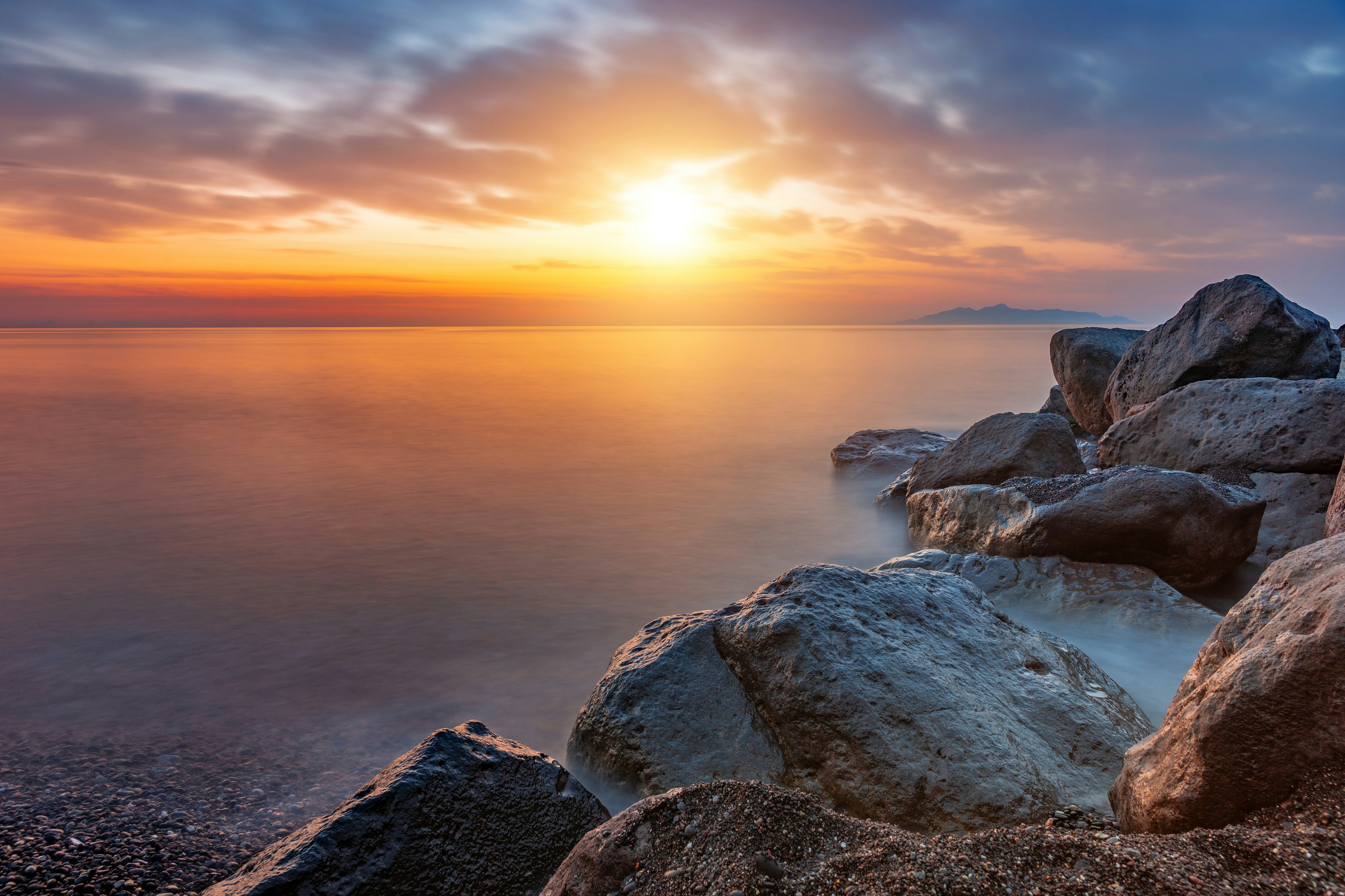 Sunlit Tides: A Rocky Shore at Dusk