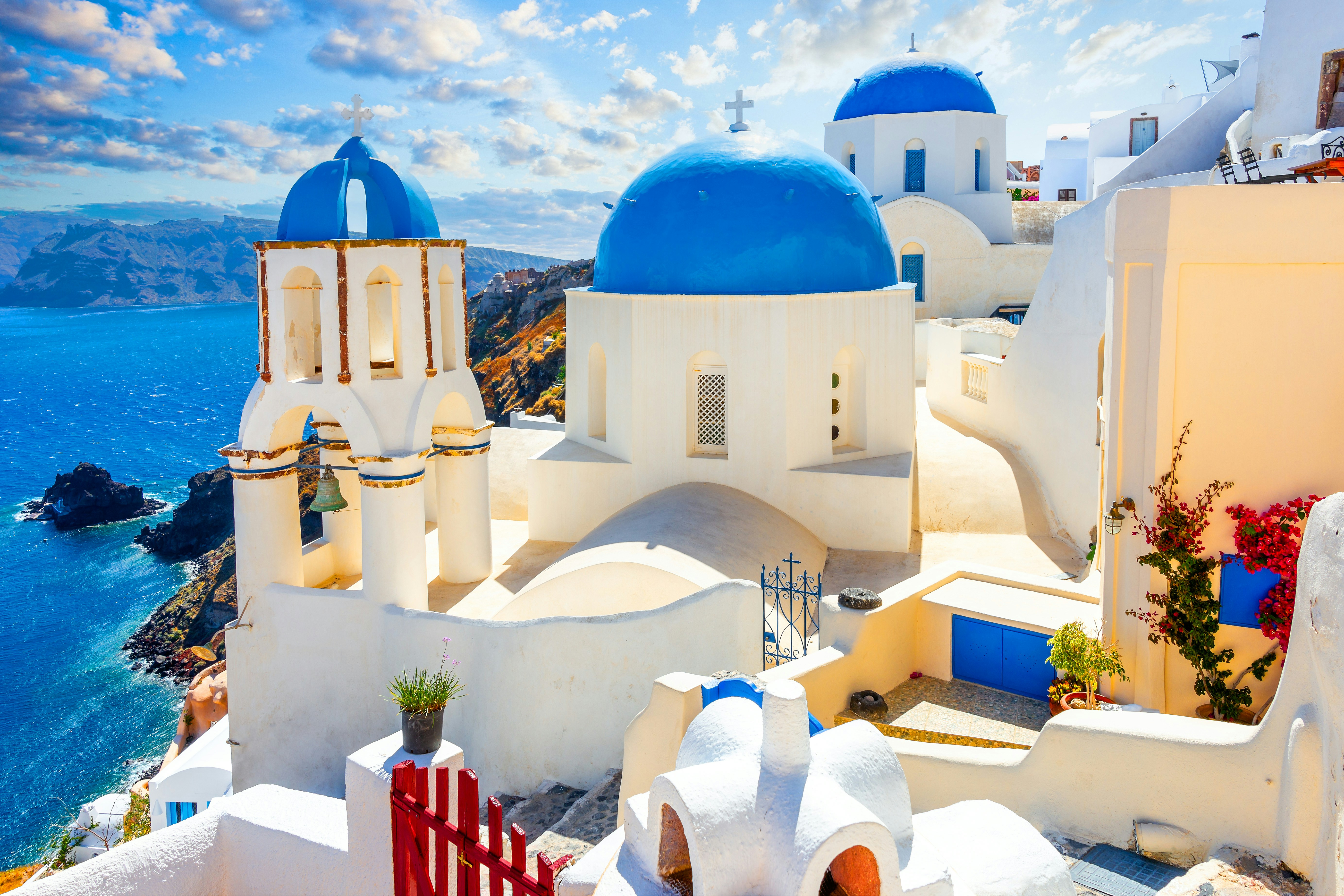 Blue Domes Above the Aegean: Santorini’s Sunlit Staircase