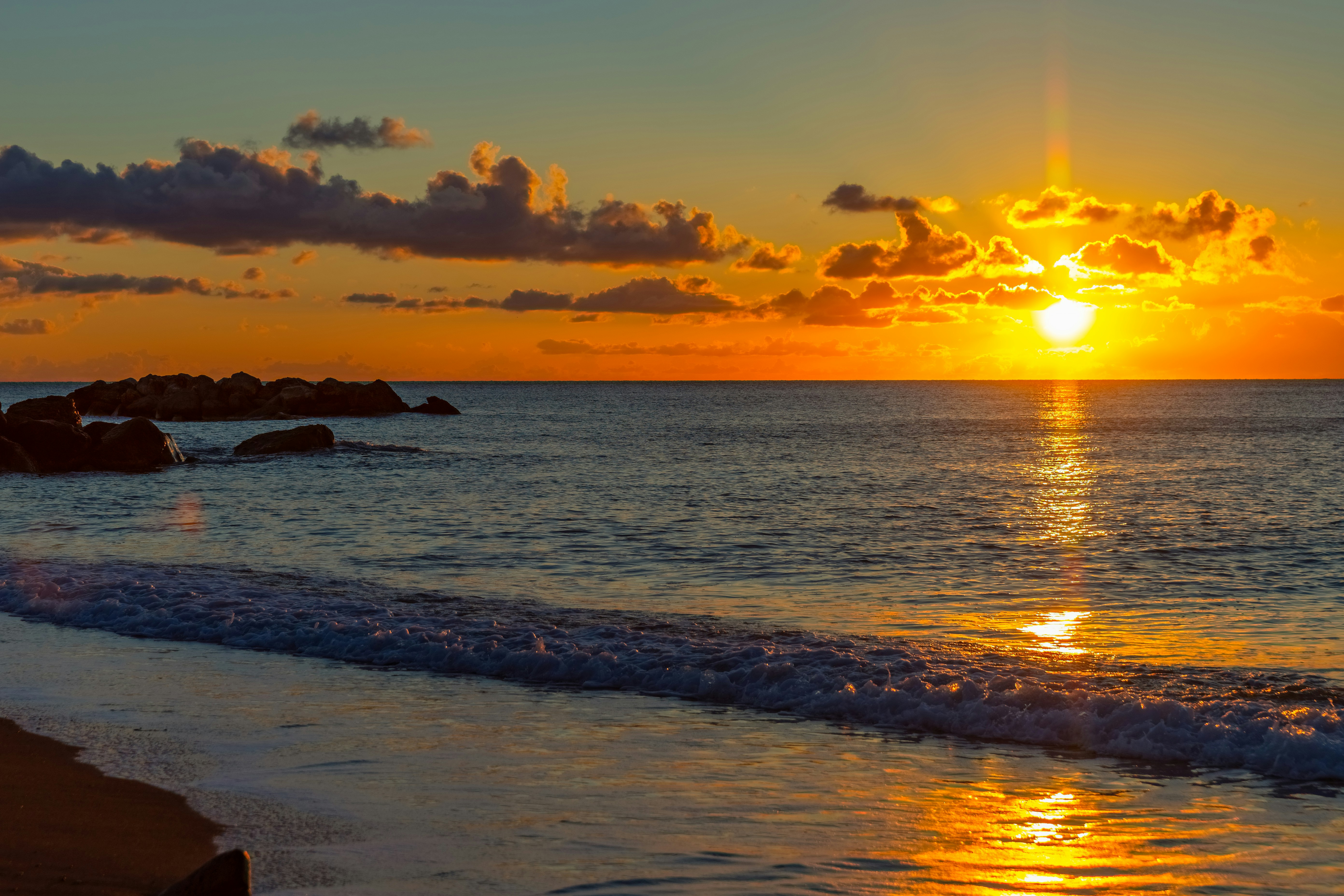 Sunlit Horizon: Golden Wave Crest at Dusk