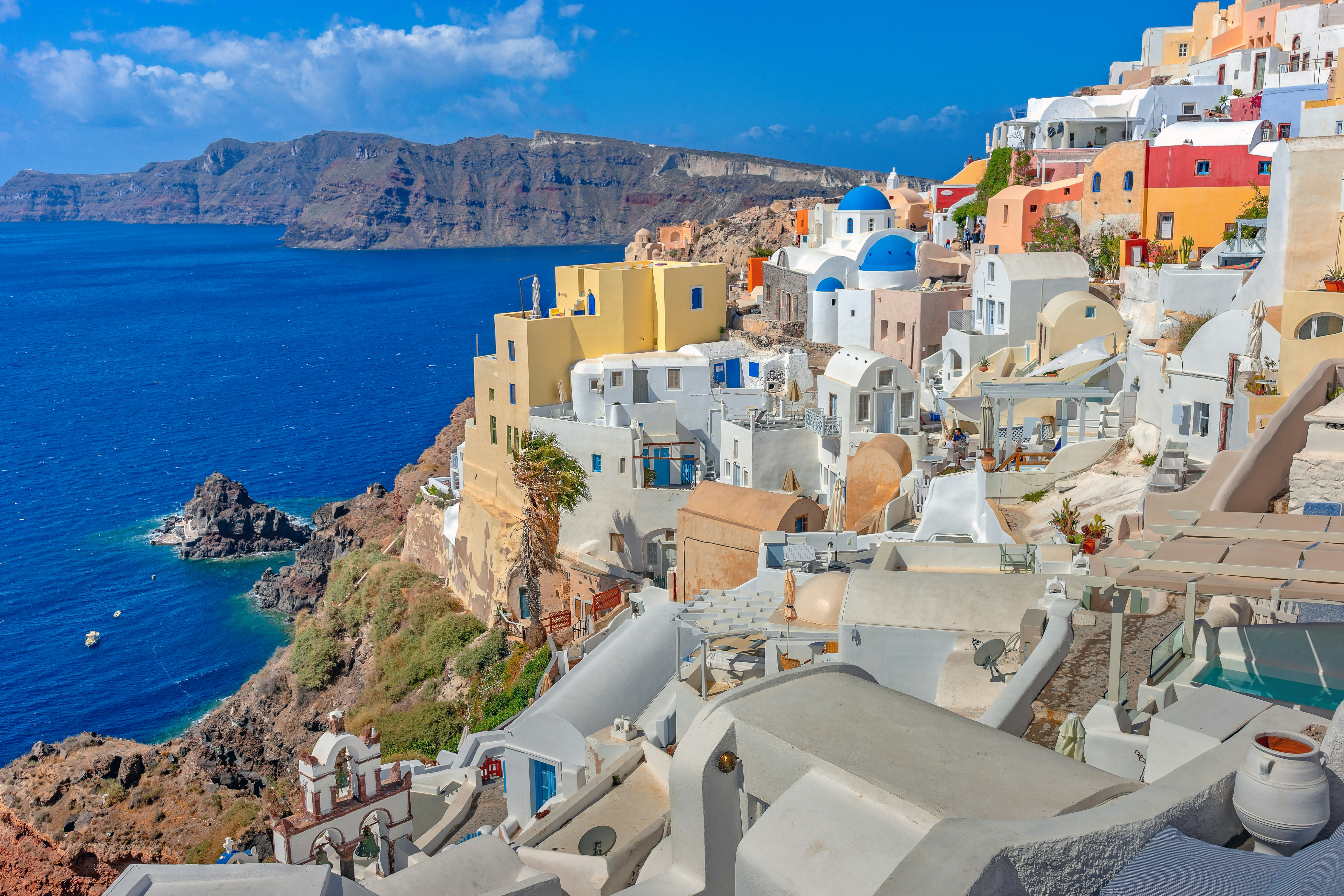 Sunlit Cycladic Village Cascading into Aegean Blue