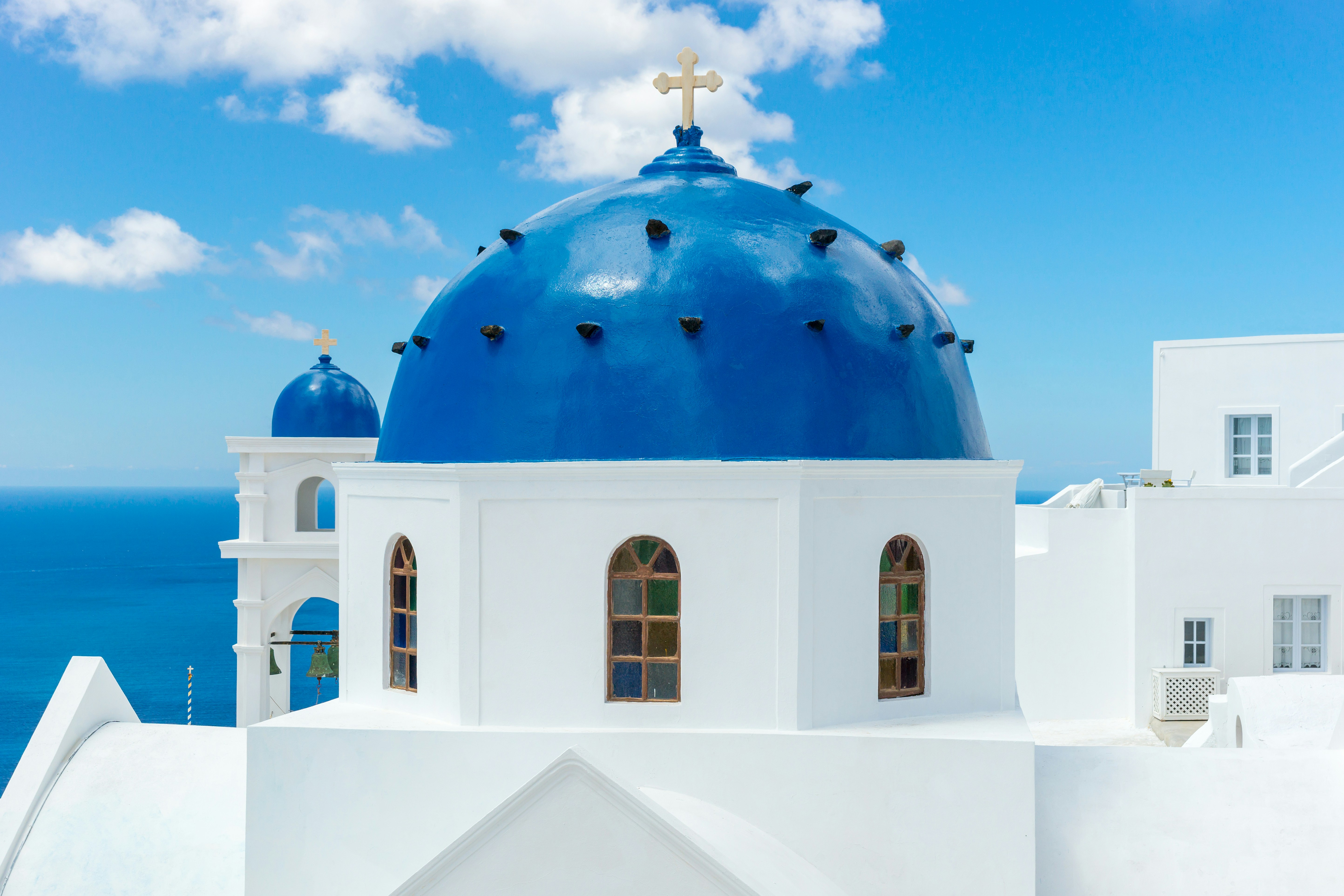 Blue Dome Horizon: Whitewashed Santorini Roofscape Against Clear Sky