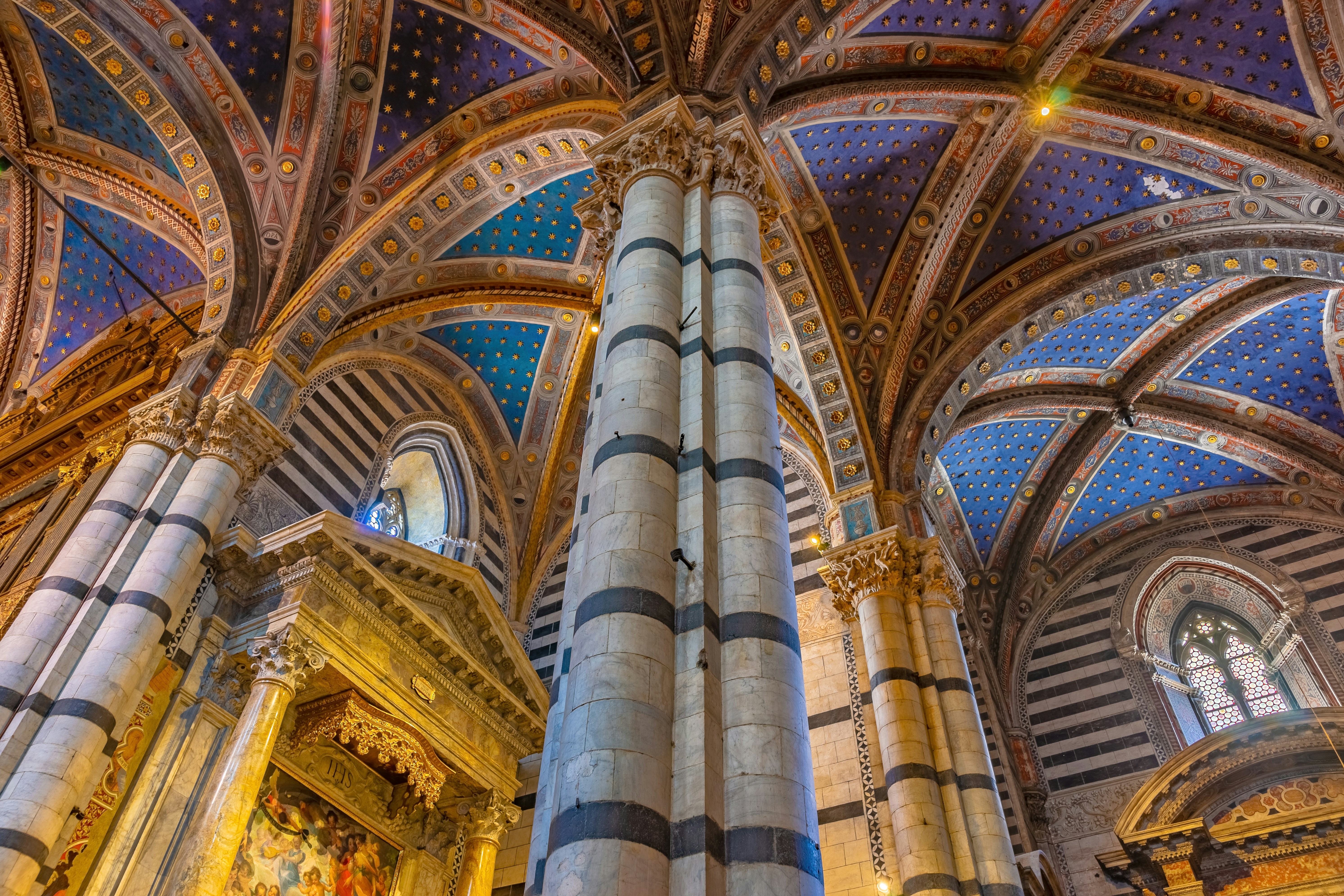Vaulted Cathedral Reverence: Striated Columns Rise Beneath Painted Groins