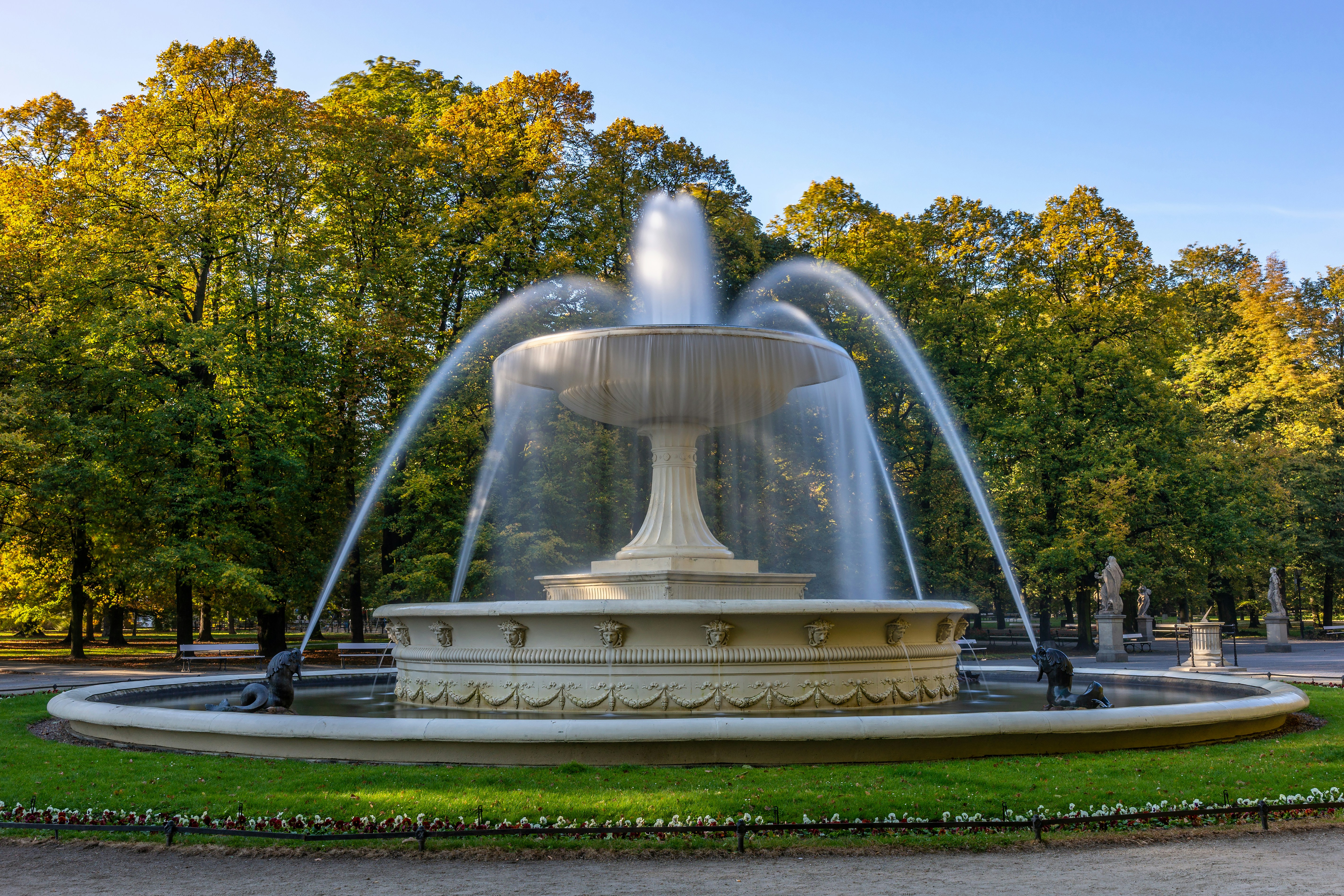 Central Jet: A Timeless Fountain Portrait Amid Autumn Trees
