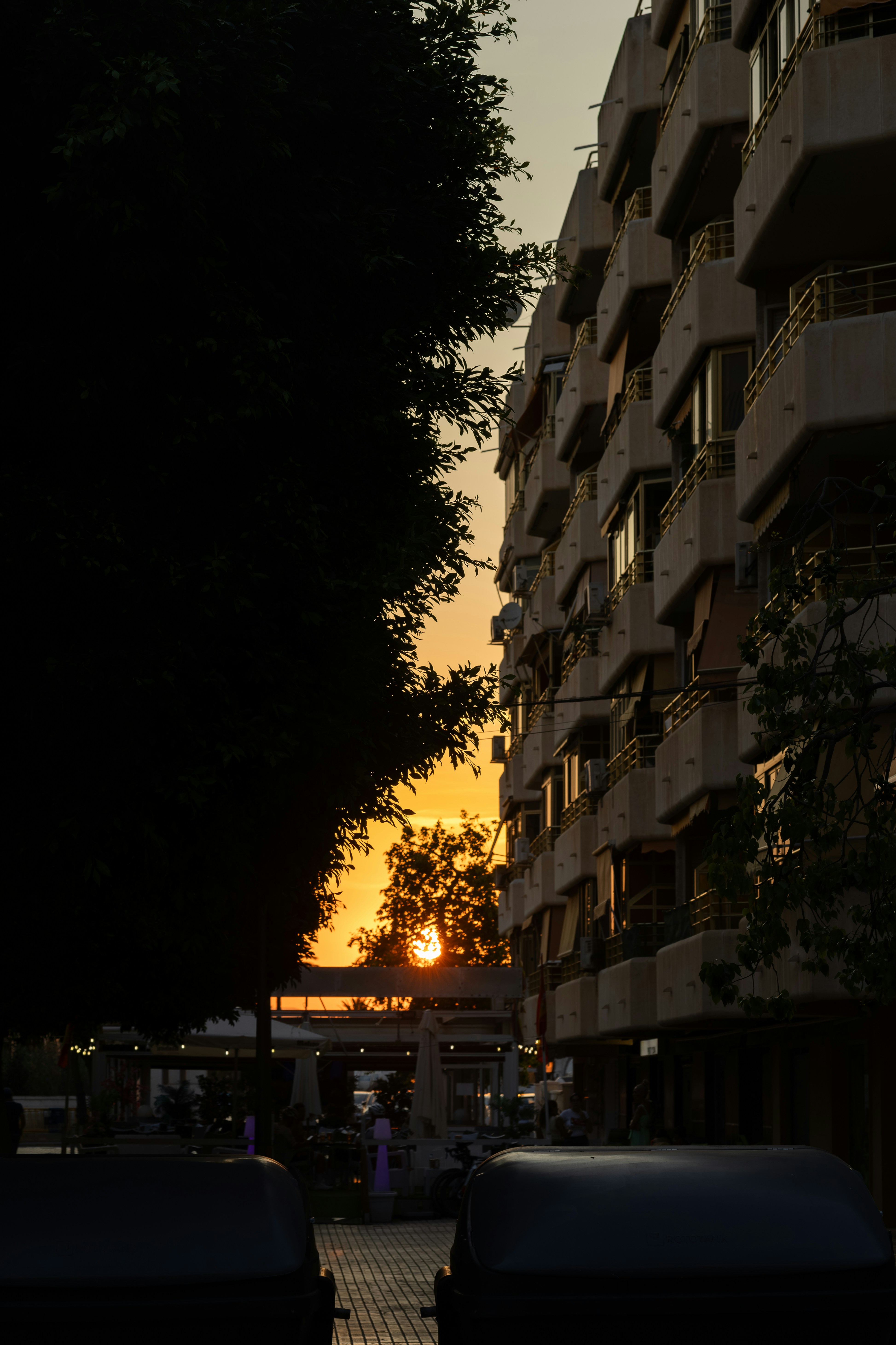 Sunlit Gap: A Towered Street Quietly Framed by Dusk