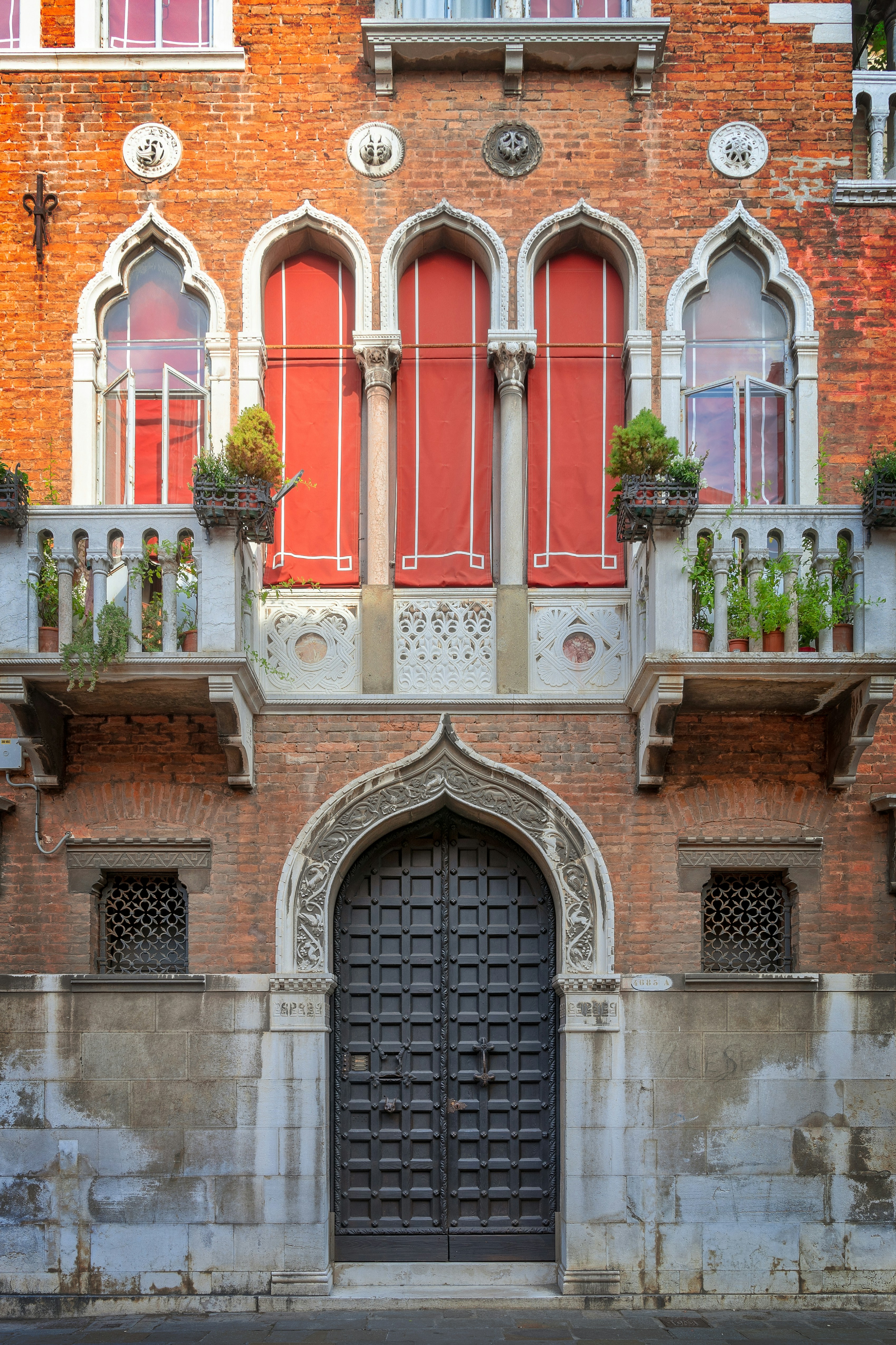 Red-Brick Gothic Revival Balcony Framing an Arched Entrance