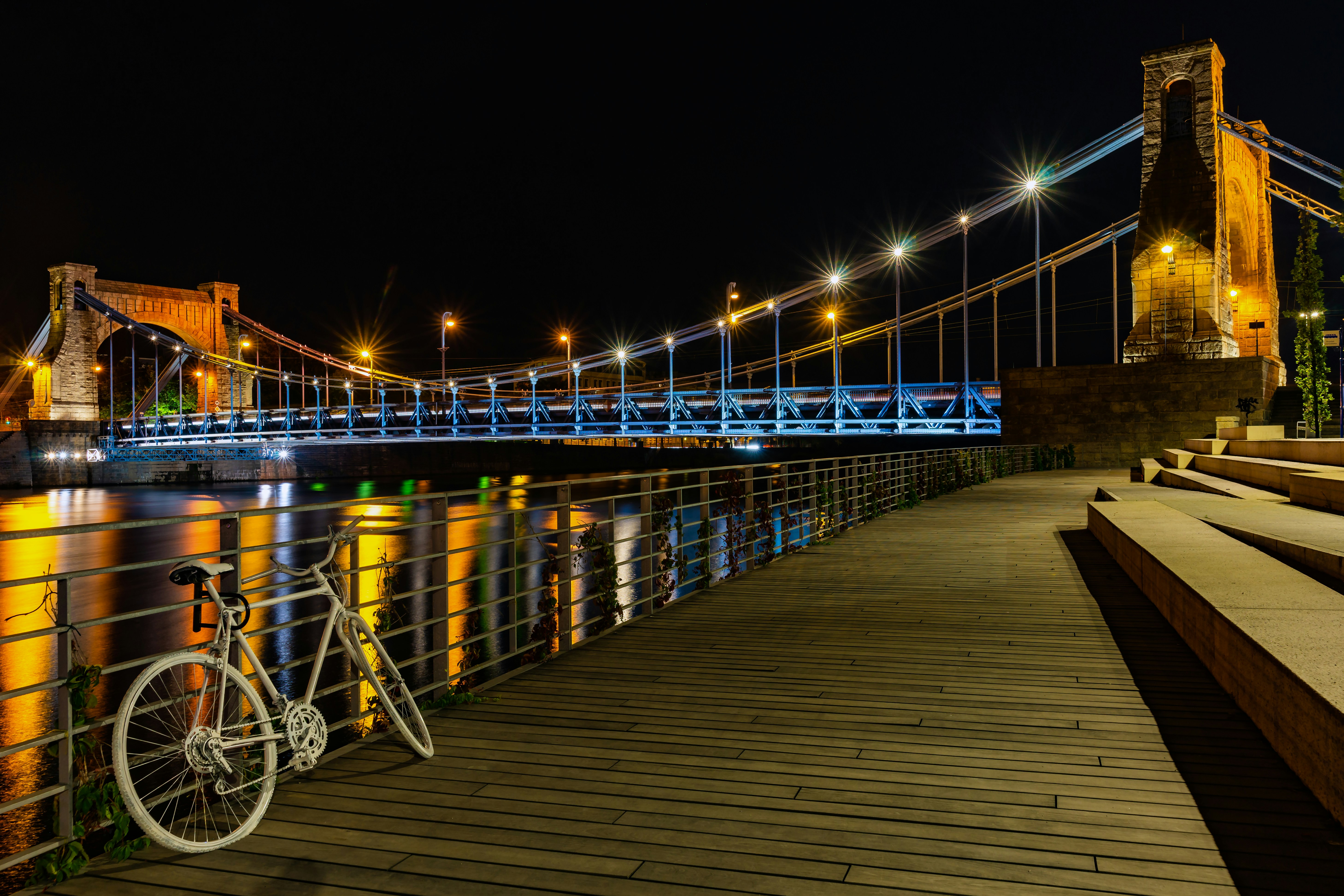 Night Riverside Bridge: Warm Lights and a Silent Bicycle