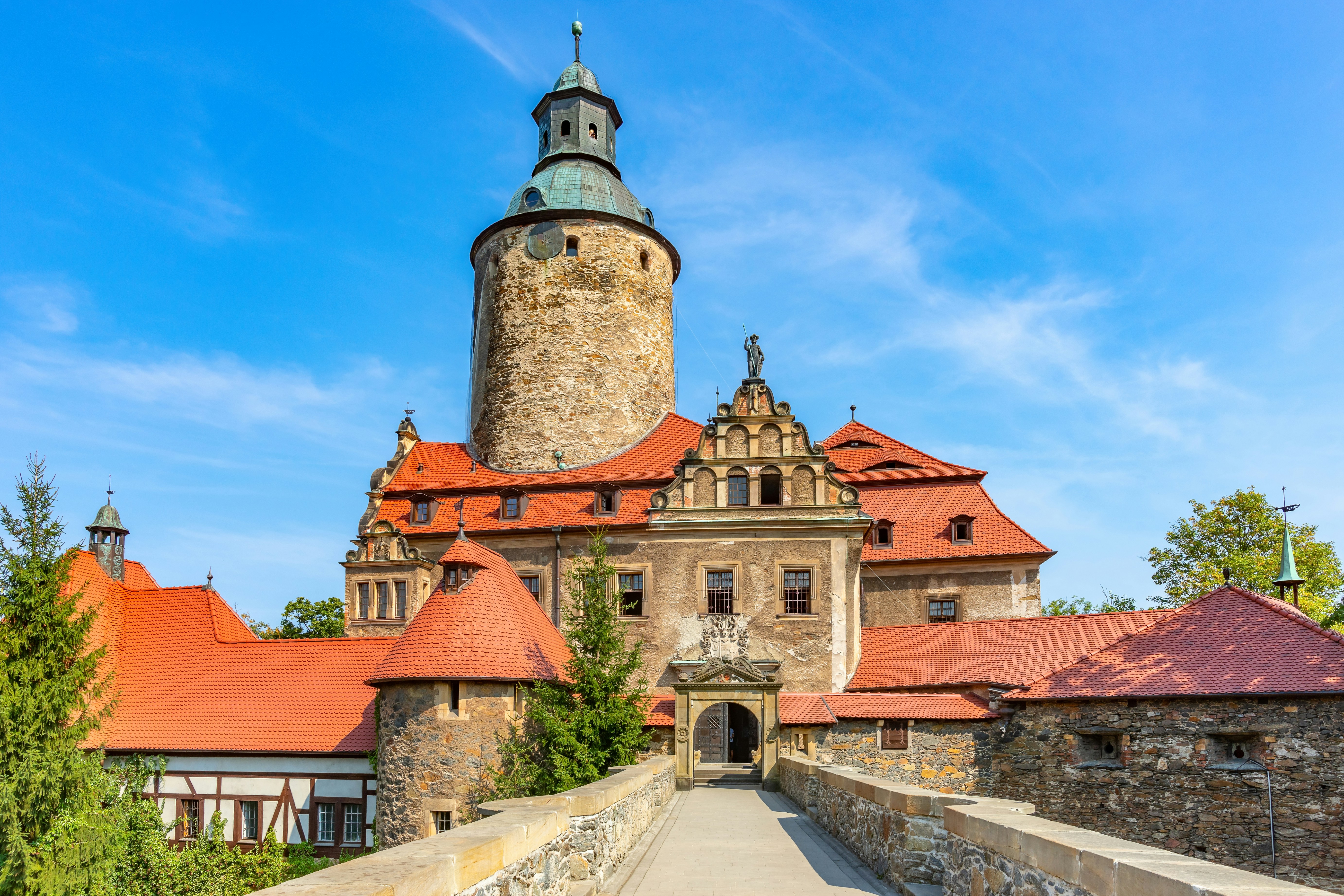 Stone Citadel at Dawn: Central Tower and Gabled Facade of a Medieval Fortress