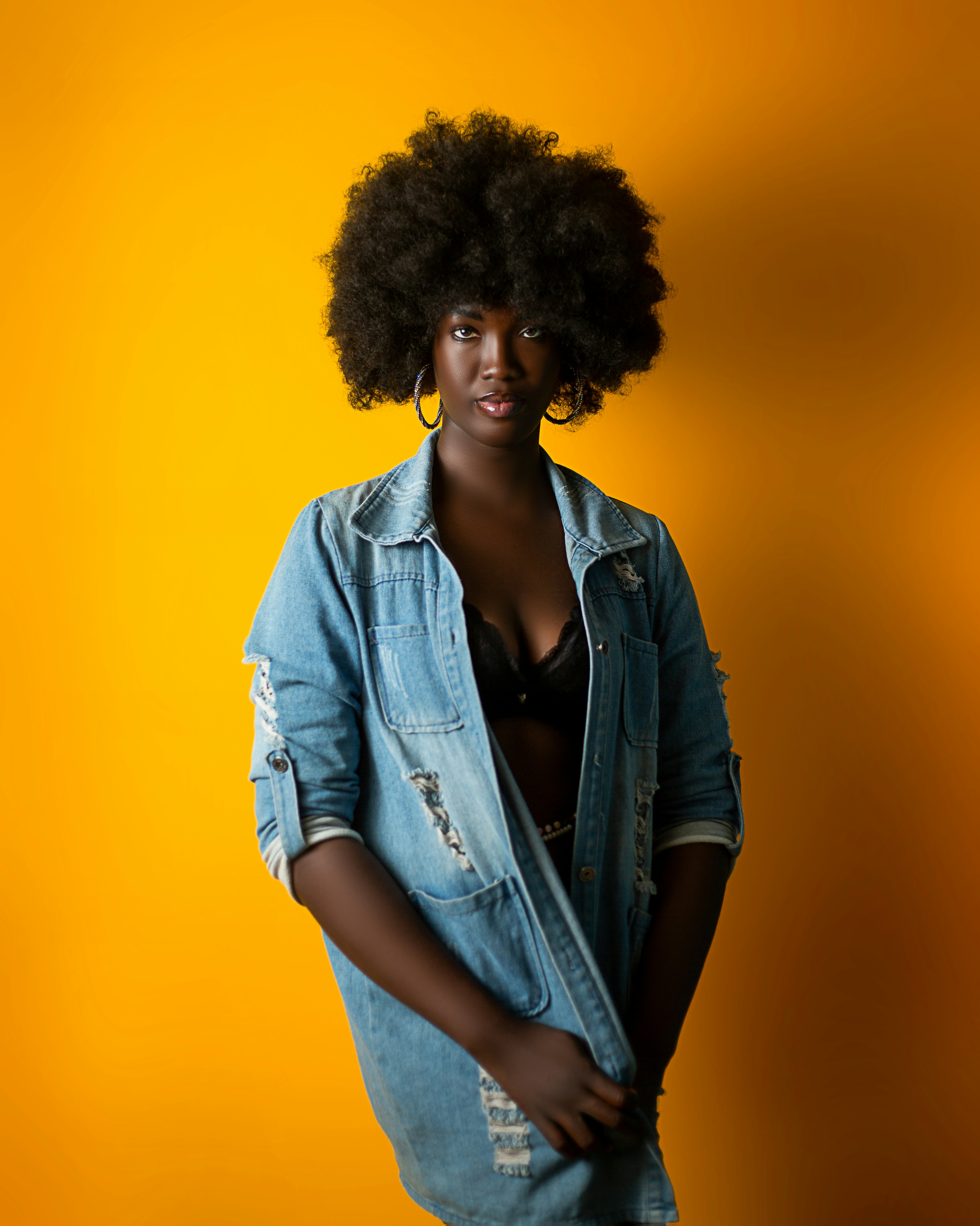 Amber Glow: Portrait of Confidence Against a Golden Backdrop
