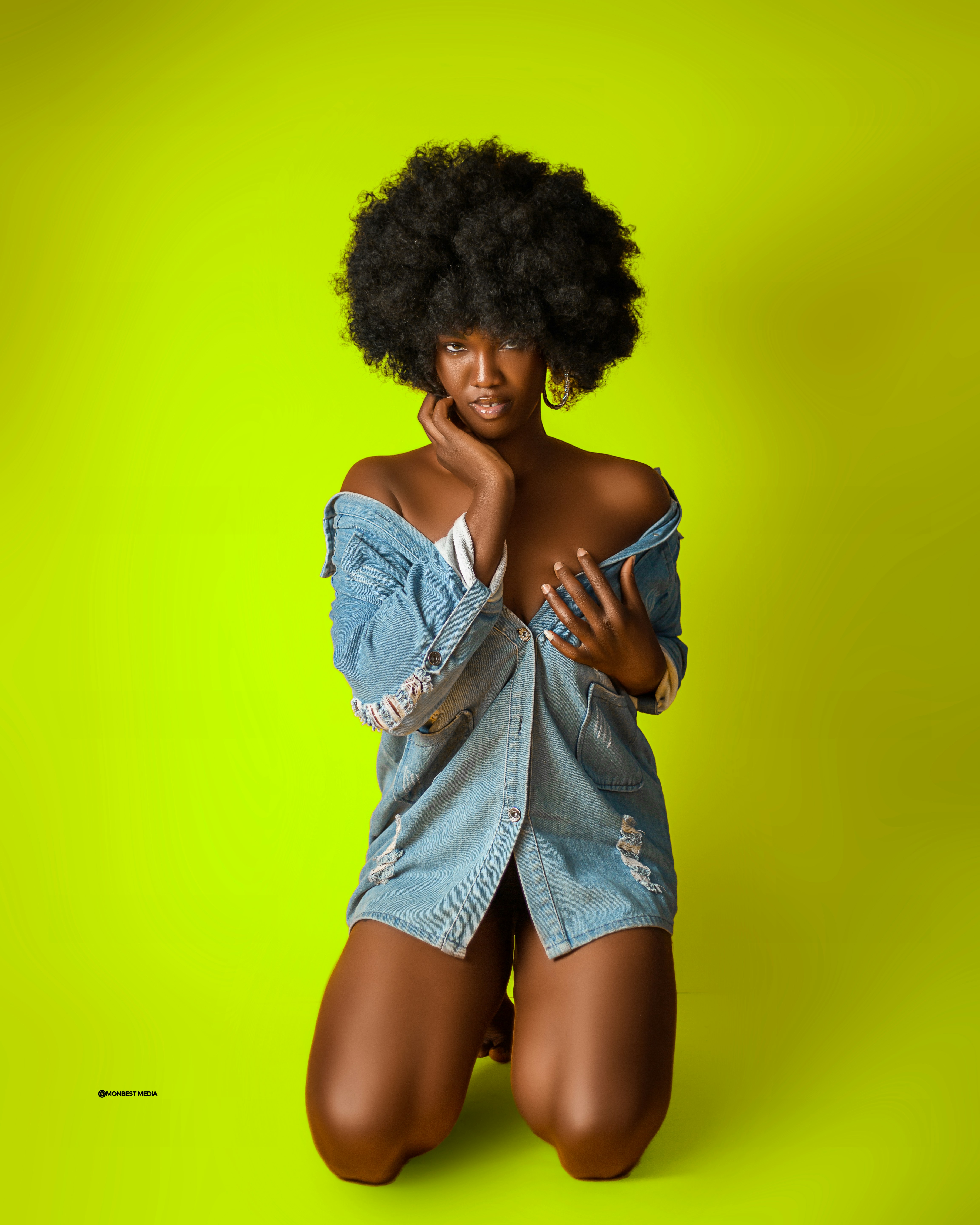 Neon Green Backdrop, Poised Afro Portrait in Denim