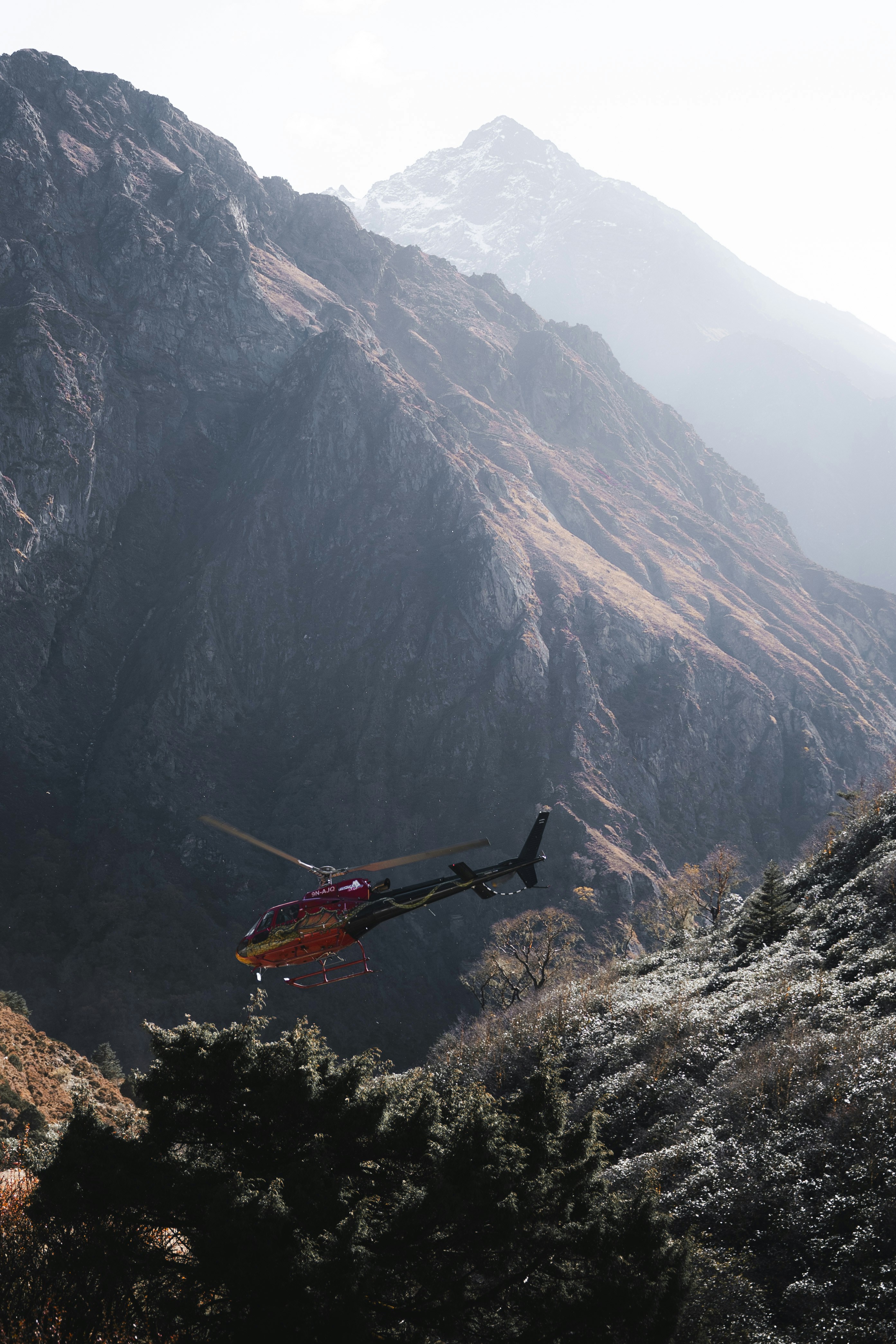  Helicopter over rugged alpine slopes amid morning light