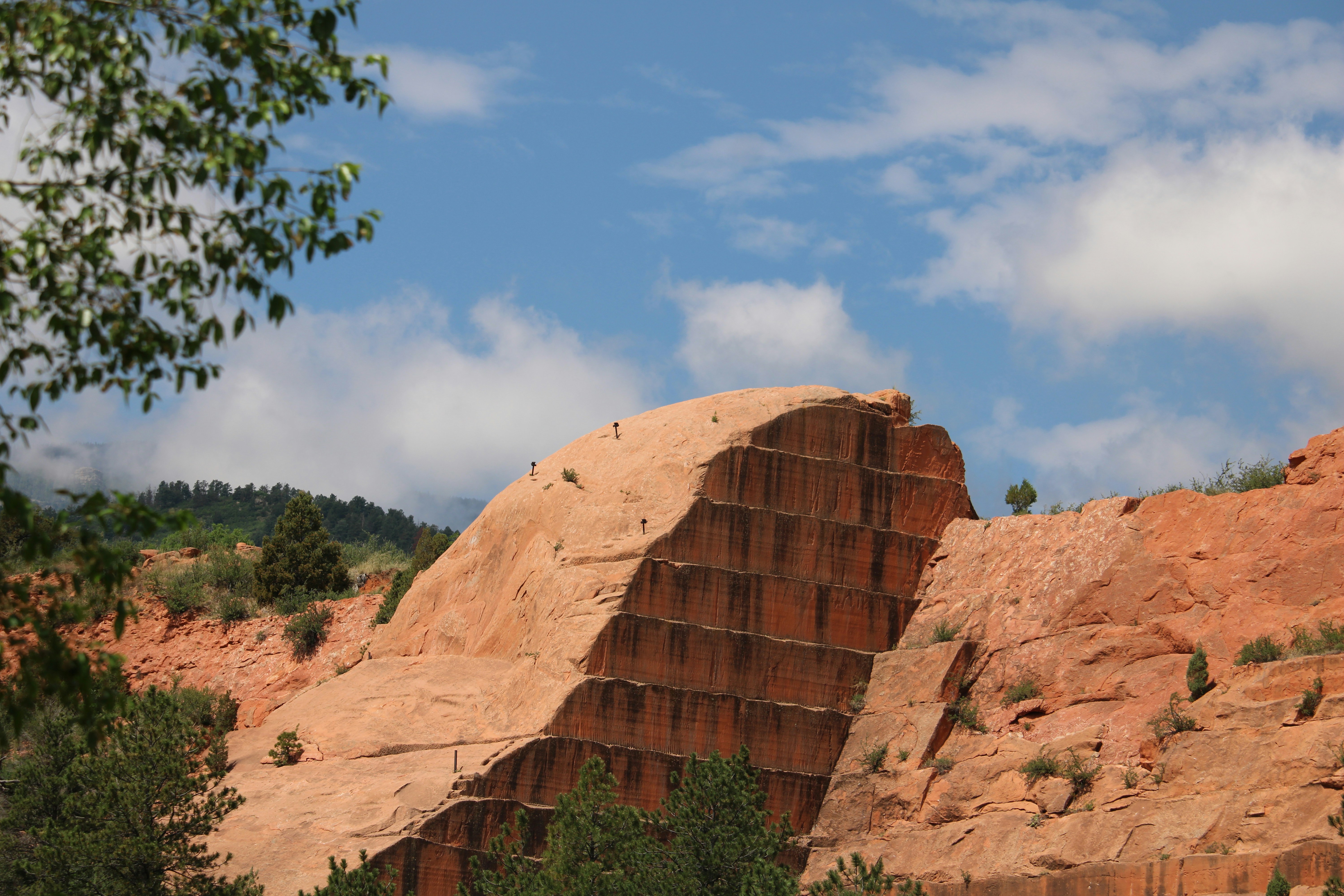 Red Rock Echoes: Terraced Cliff Face Beneath a Quiet Sky