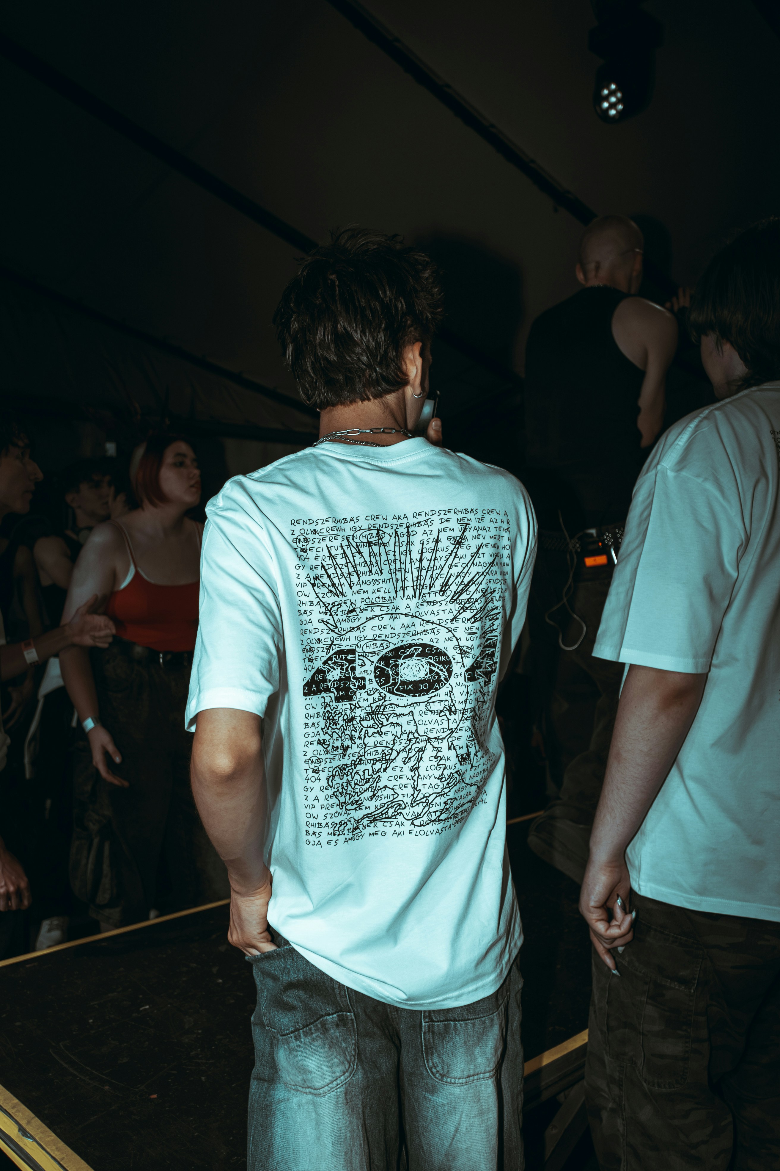Back View at the Pulse: Neon Tee Under Club Lights