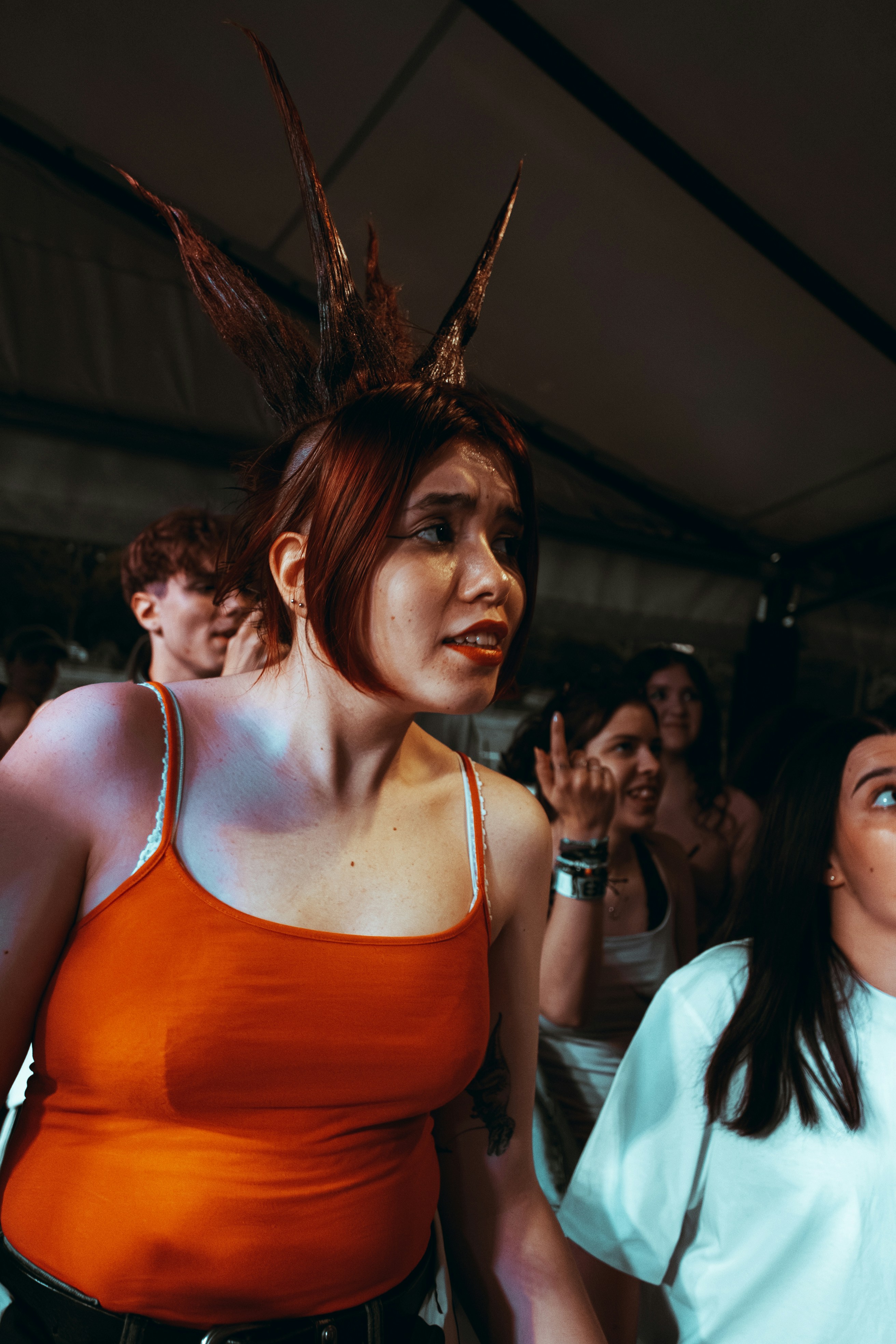 Mid-Event Spotlight: A Red-Haired Performer Under Head-Tier Antlers