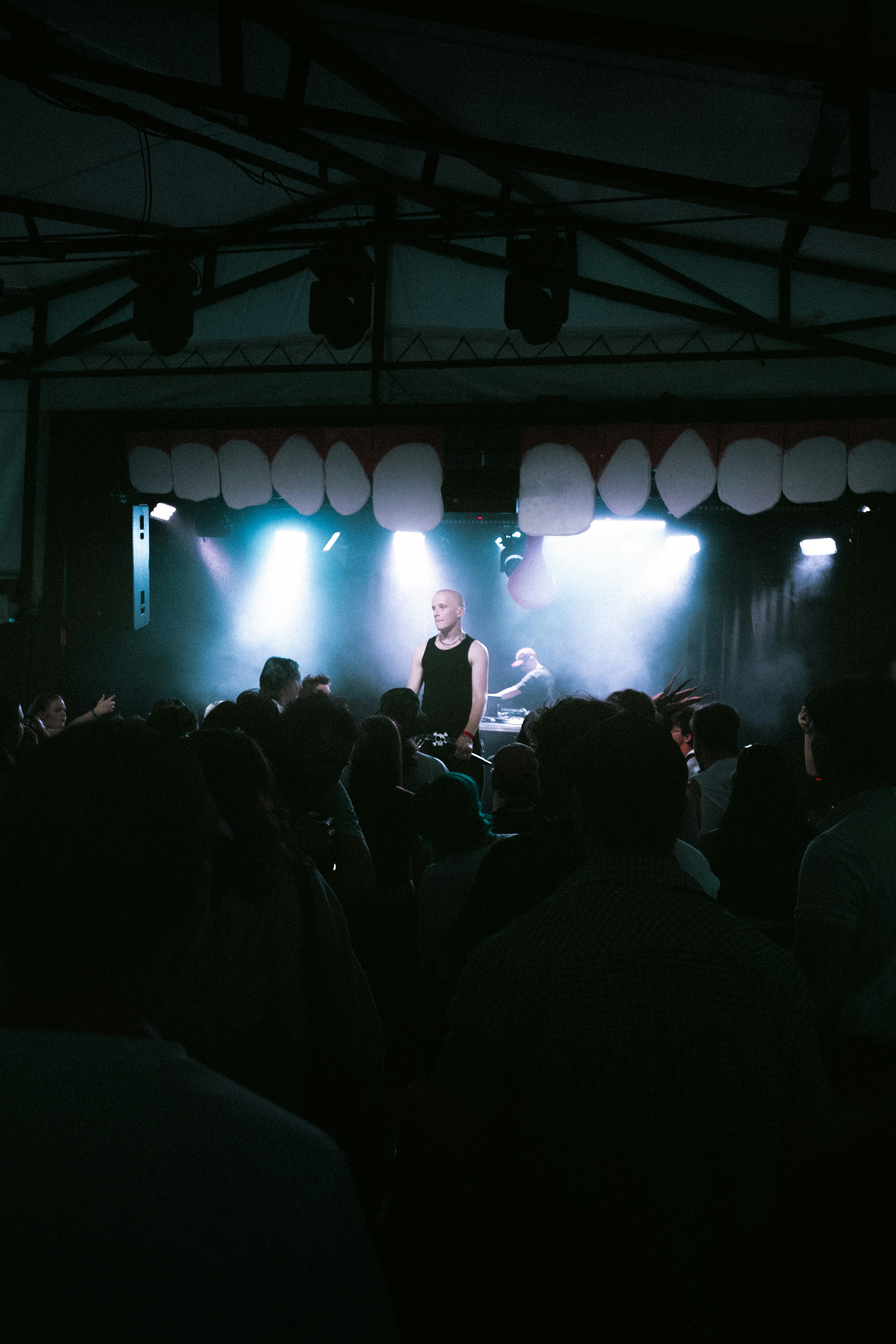 Center Stage: A Solo Performer Amid a Nightclub Crowd