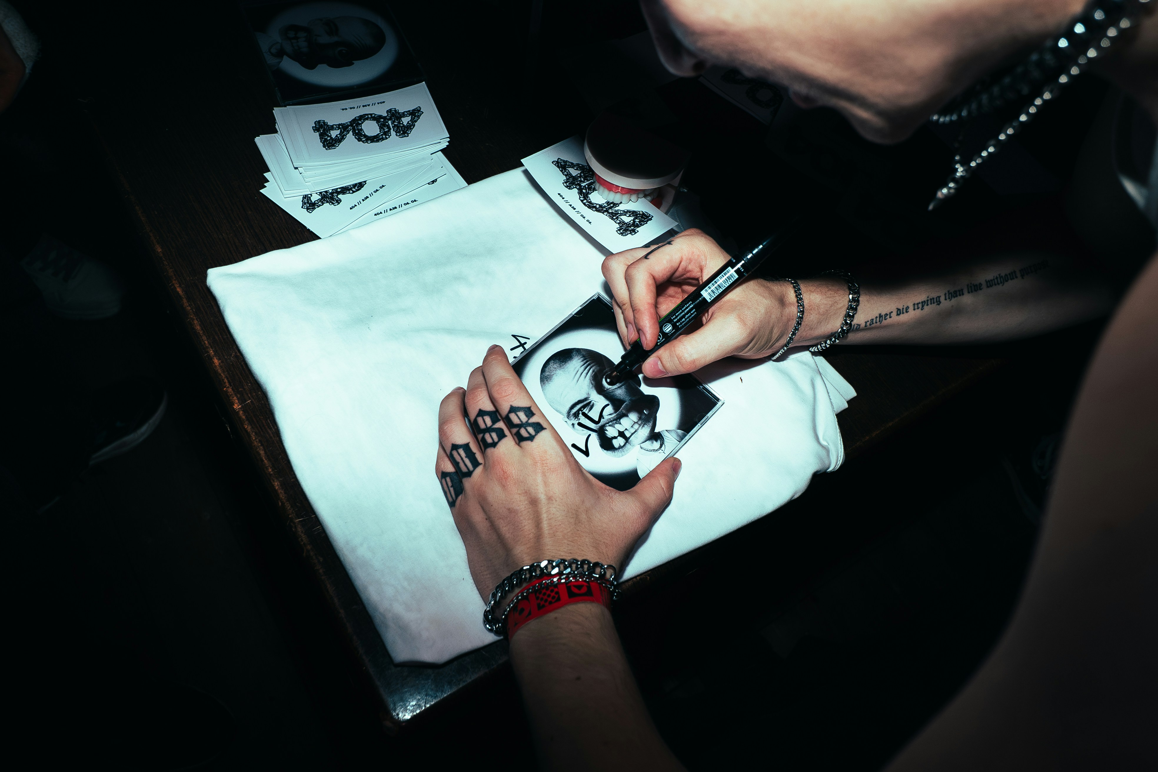 Ink, Thread, and Cards: Hands Craft a Portrait in Black Light