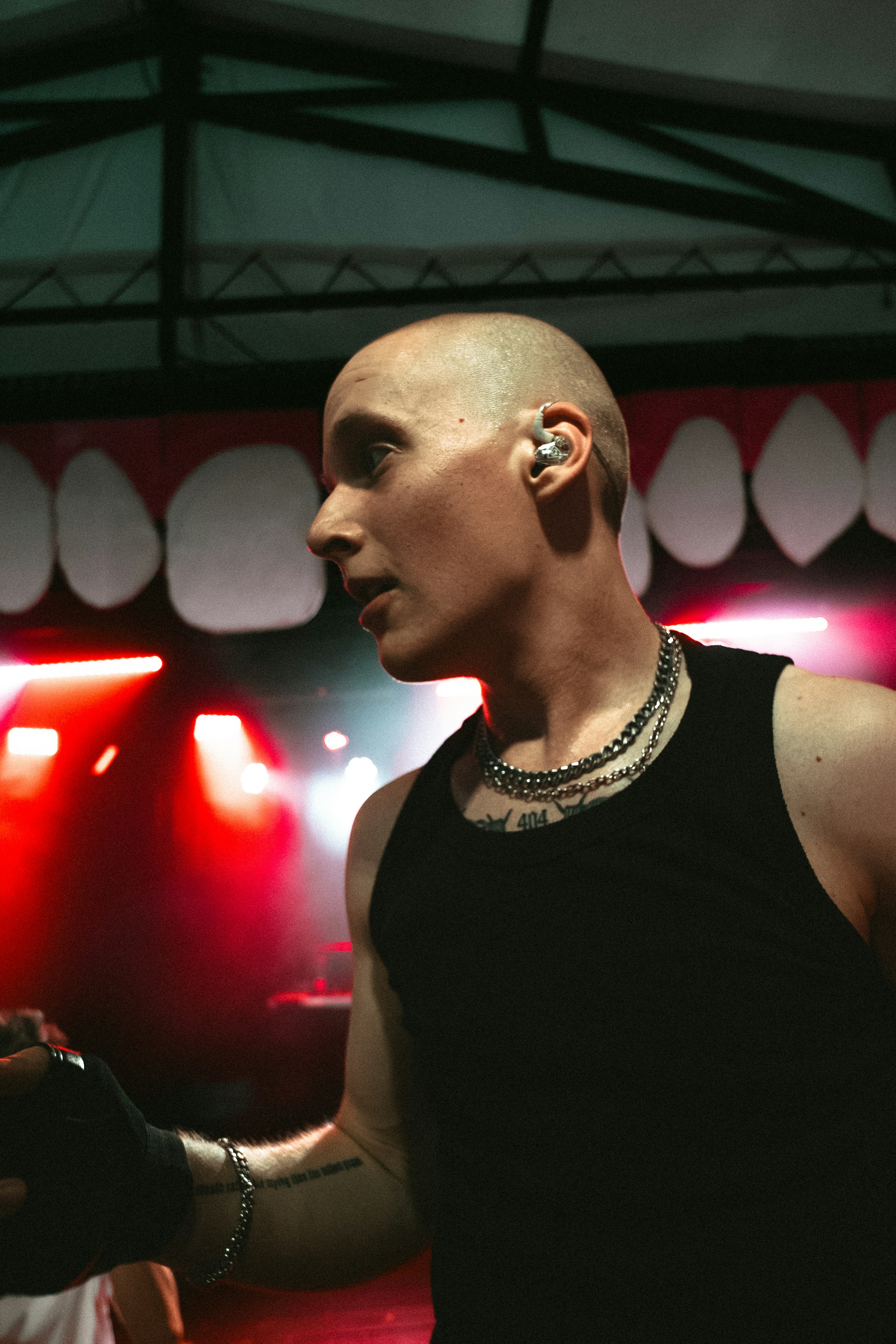 Bald Frontman in Neon Spotlight
