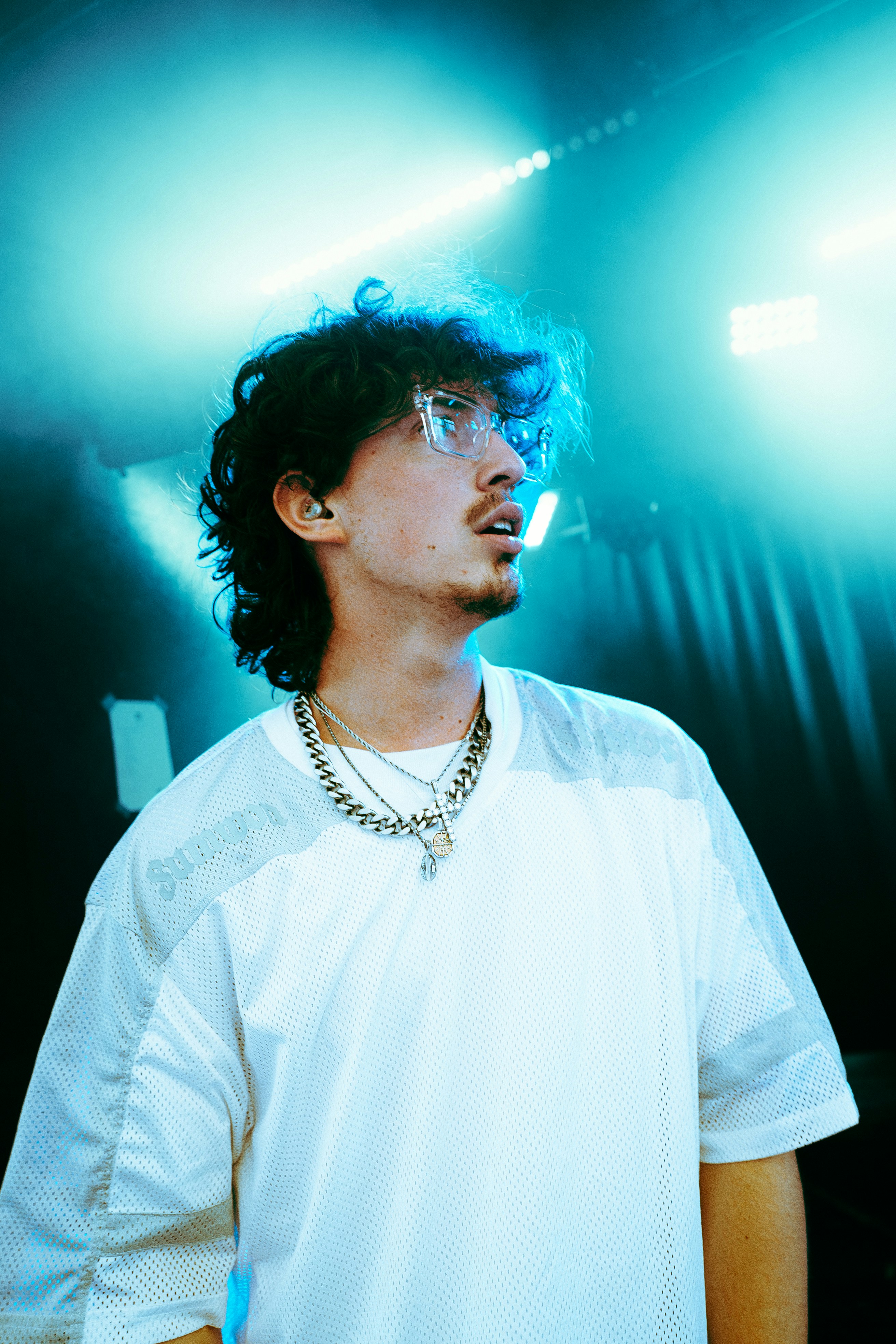 Neon Summit: A Glassy Gaze Under Stage Lights