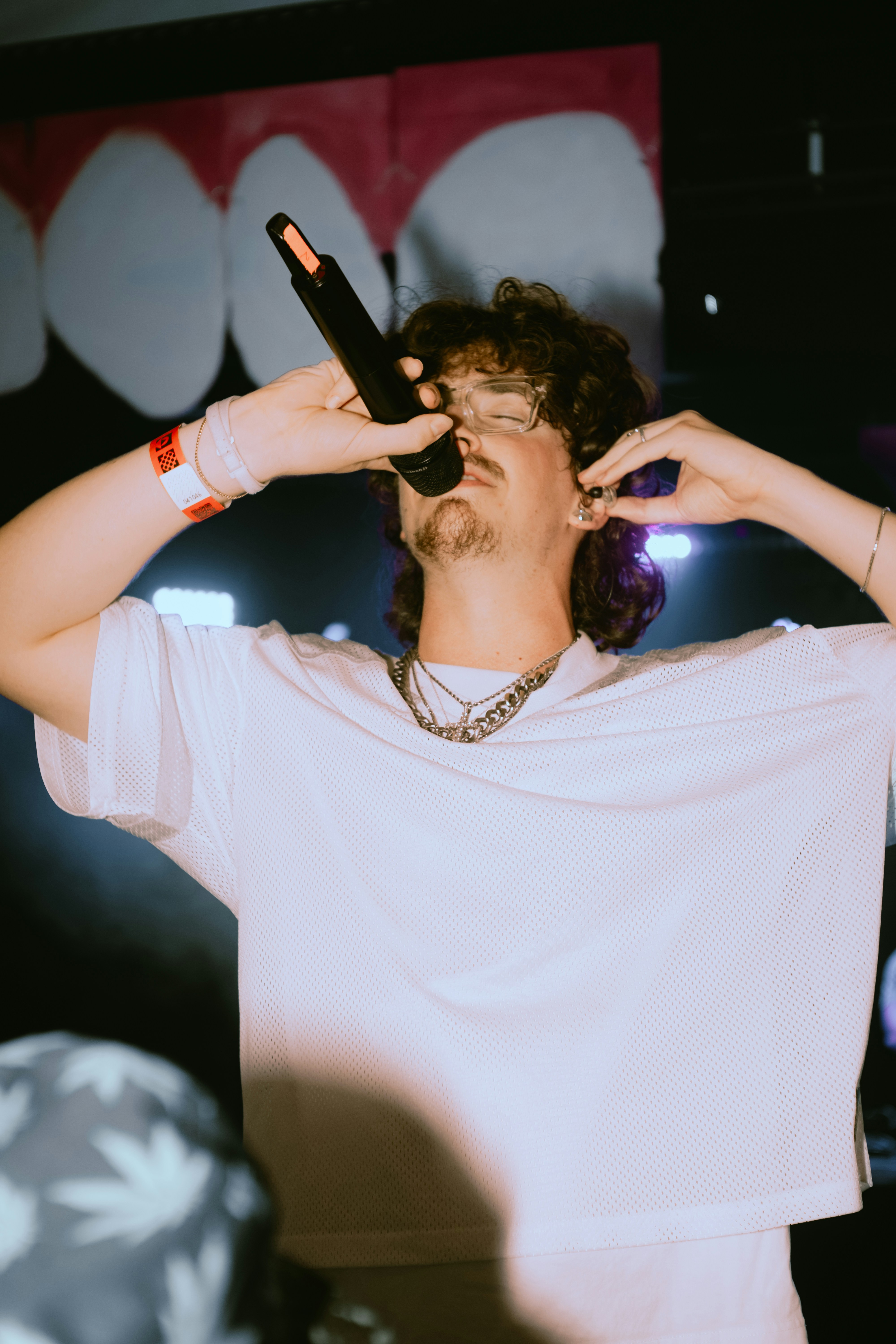 Microphone Inferno: A Live Moment with Spotlight and Smoke