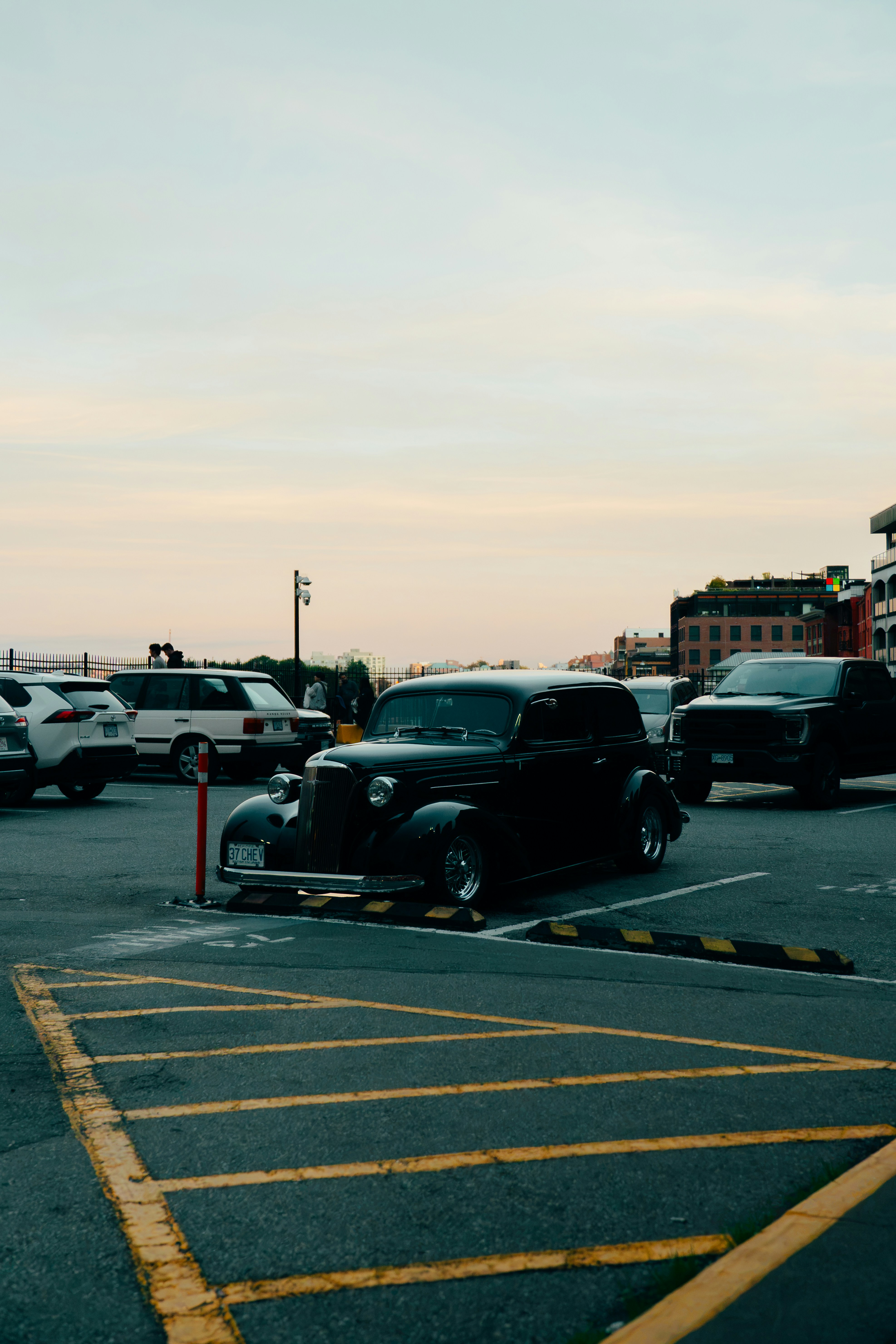Dark Convertible in a Quiet Parking Lot at Dusk