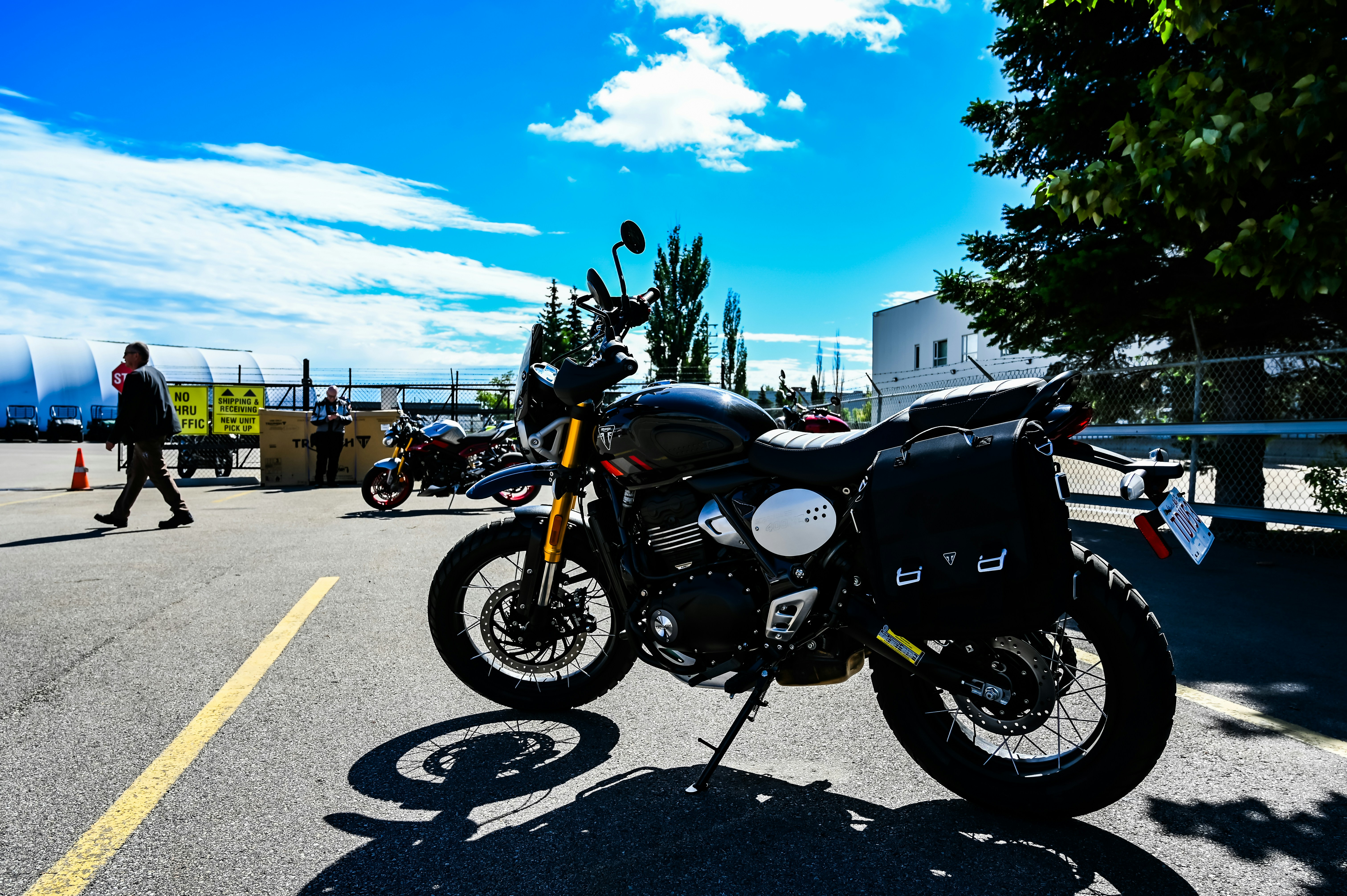Sunlit Triumph: A Rugged Motorcycle in a Bright Lot