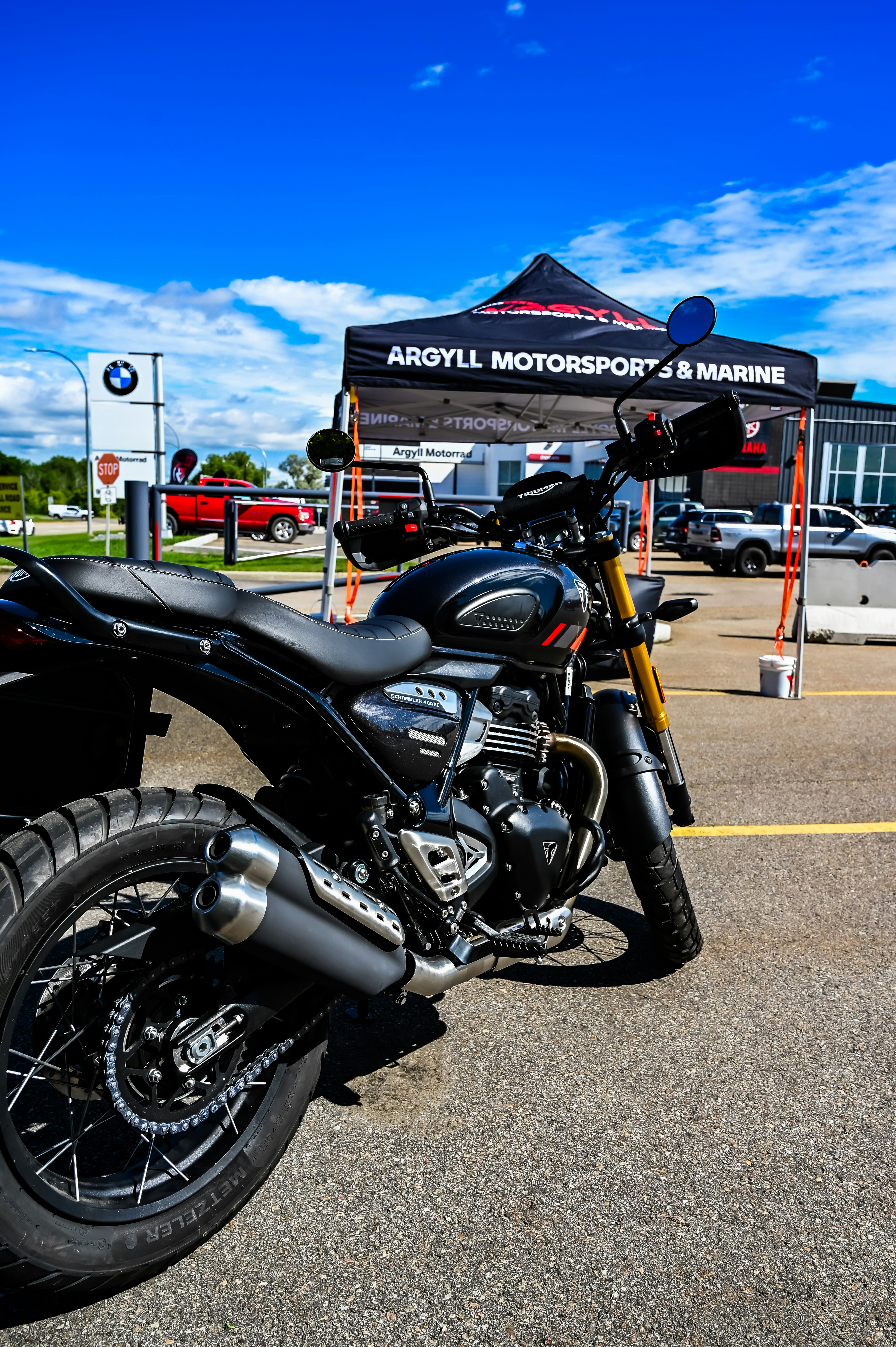 Shadowed Street King: A Triumph Stands Quietly Before the Tent