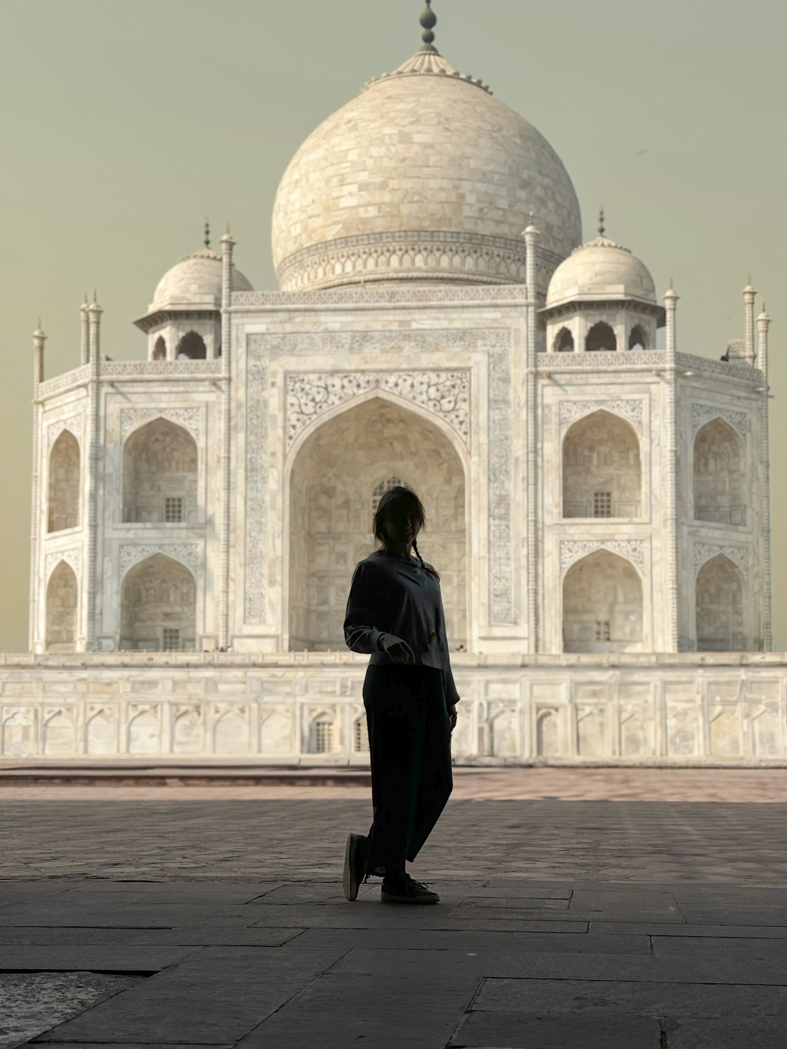 Silhouette at the Gateway: A Traveler Before the Taj