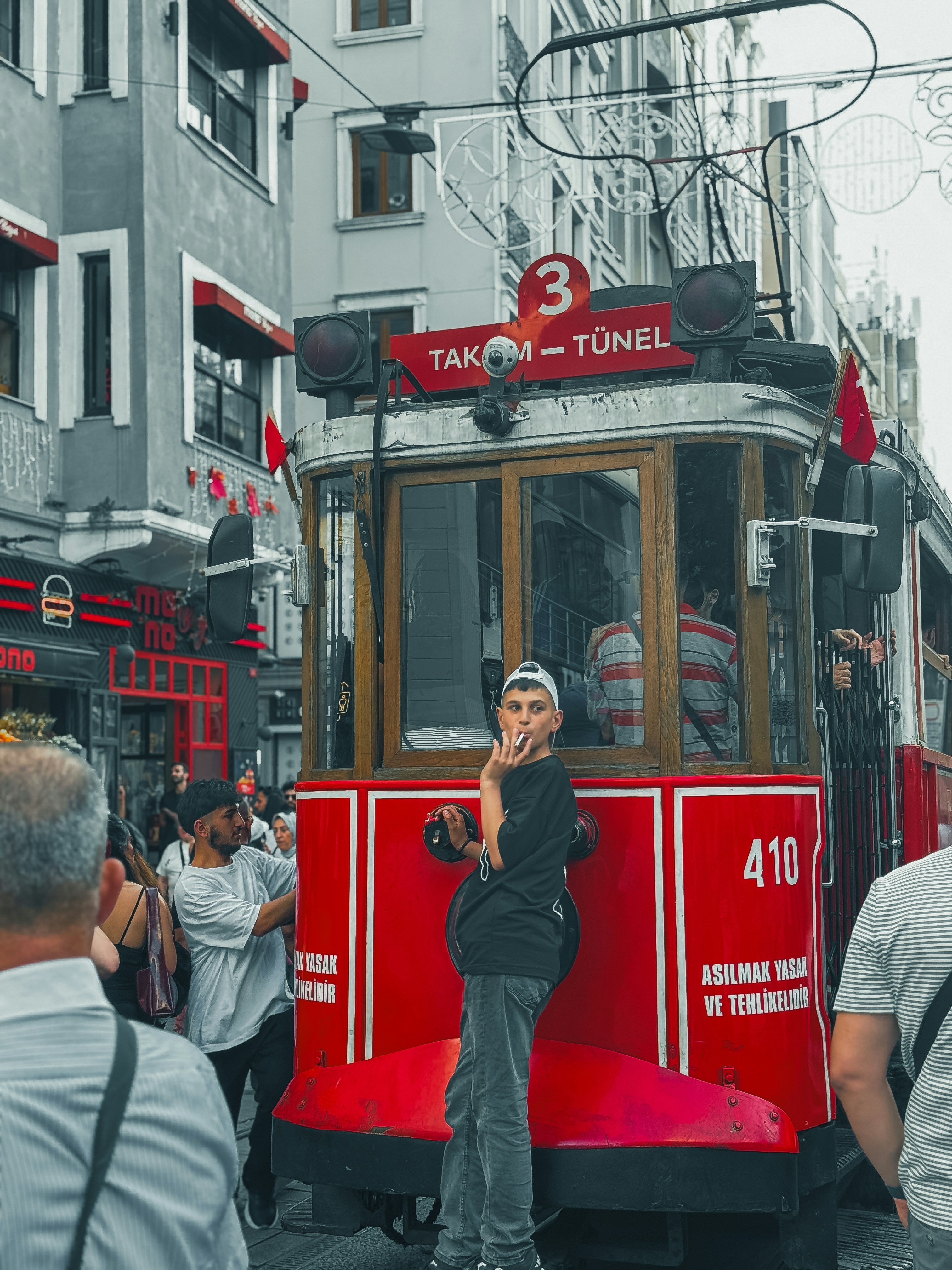 Red Tram Sudden Portrait: A Moment of Stare on a Busy Istanbul Street