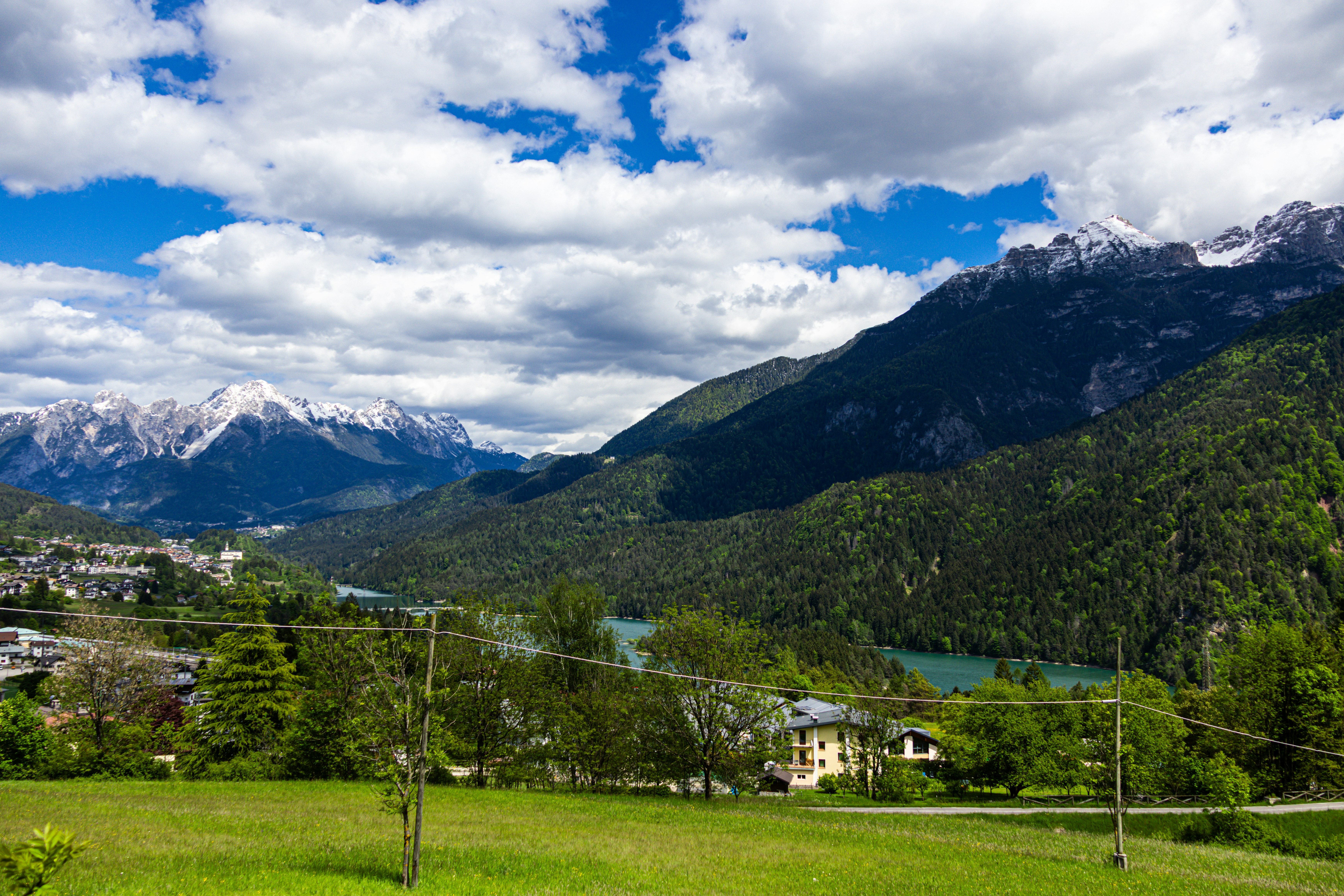 Alpine Valley Panorama with Snow-Capped Peaks and Lake Ribbon