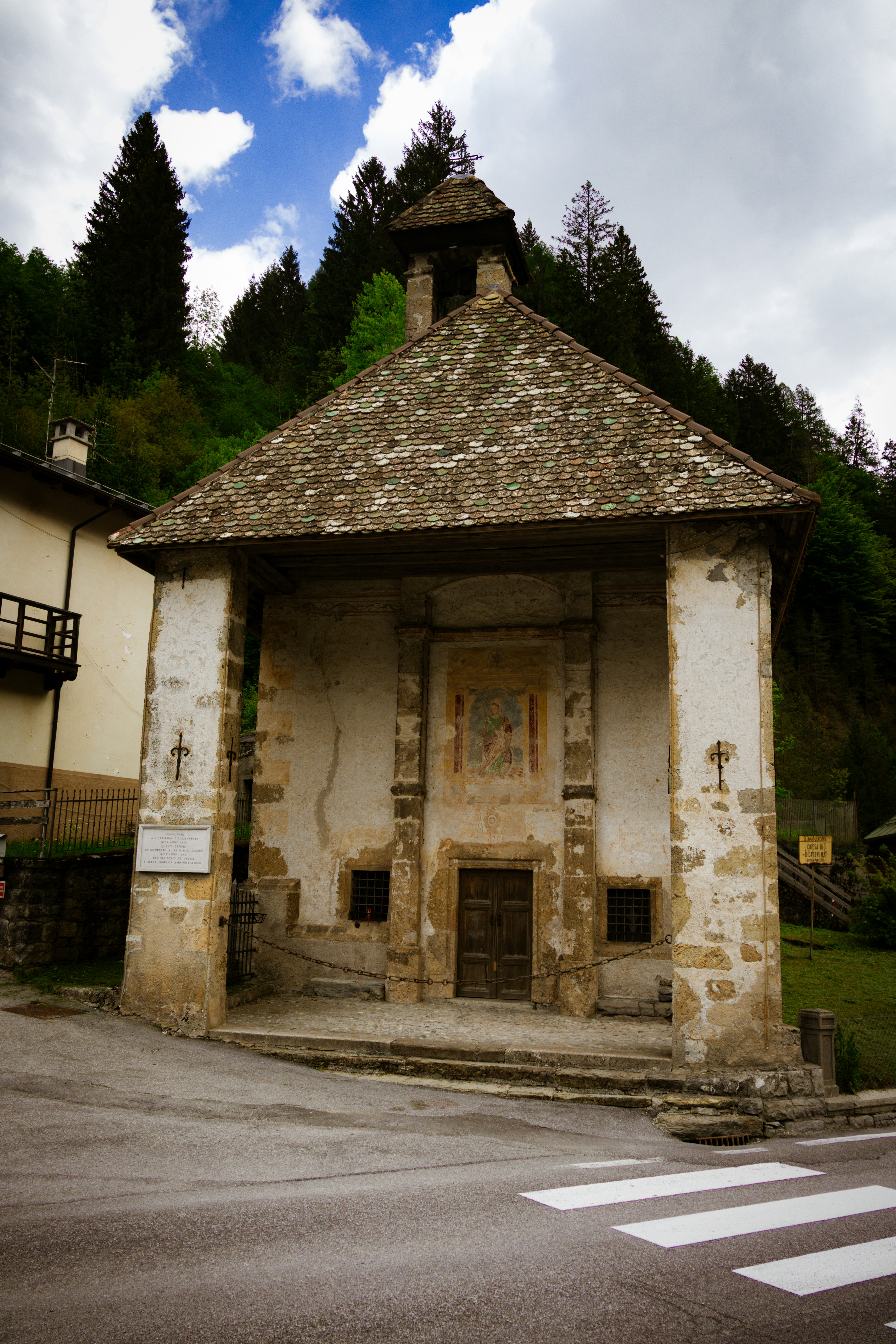 Stone Chapel with Sloped Tile Roof at an Alpine Road Corner