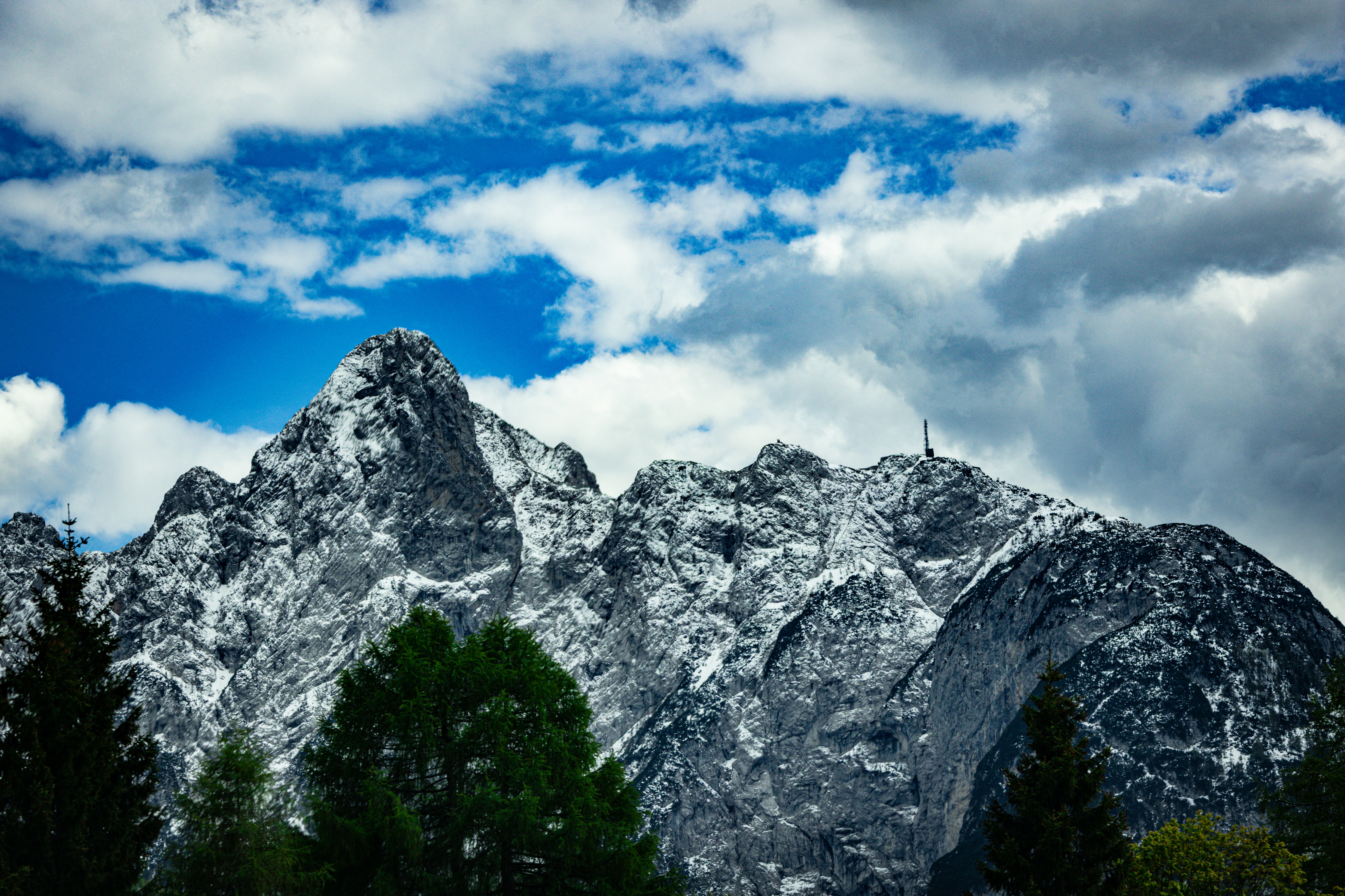 Snow-dusted Peaks Under a Patchwork Sky