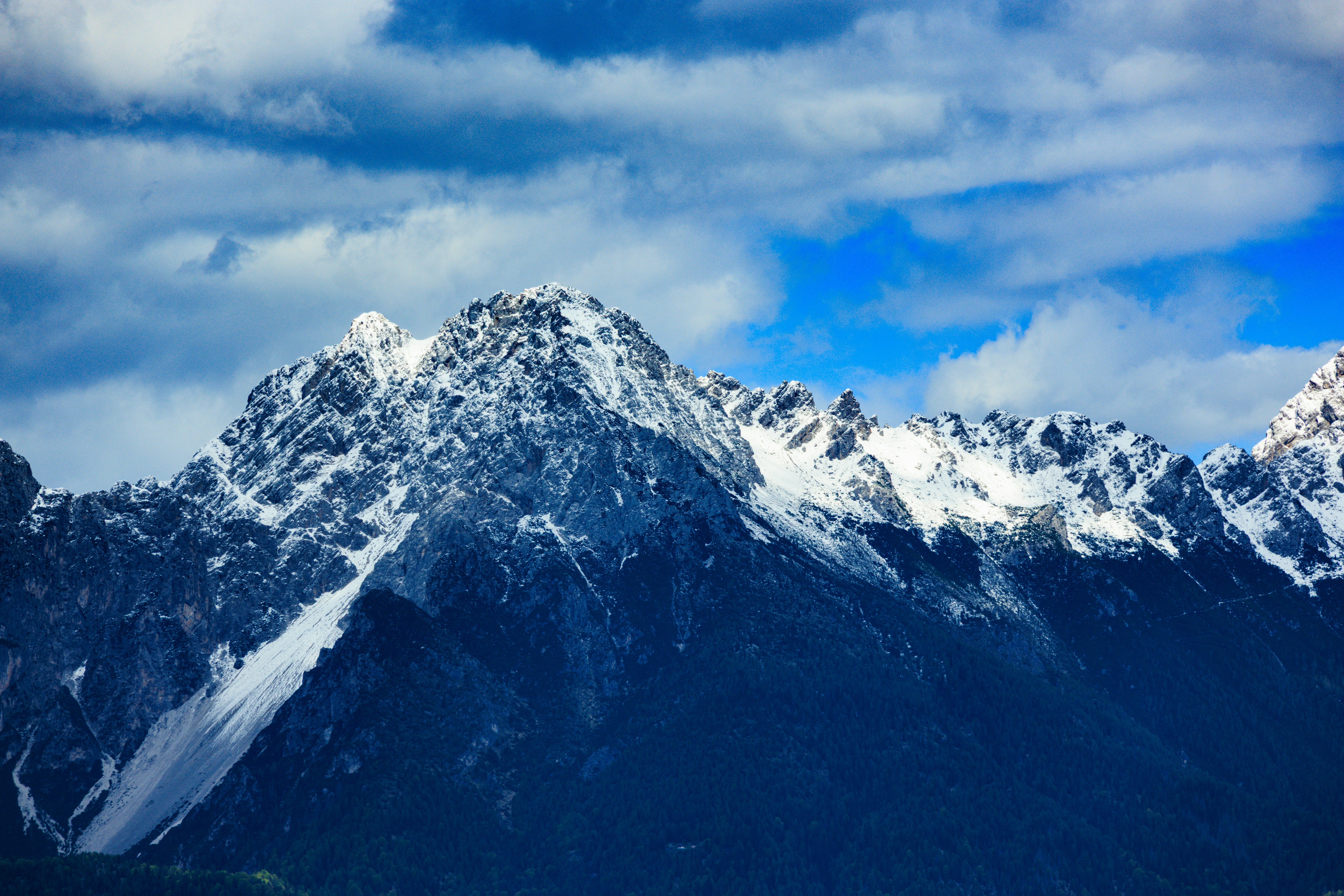 Snow-capped Peak Under a Luminous Alpine Sky