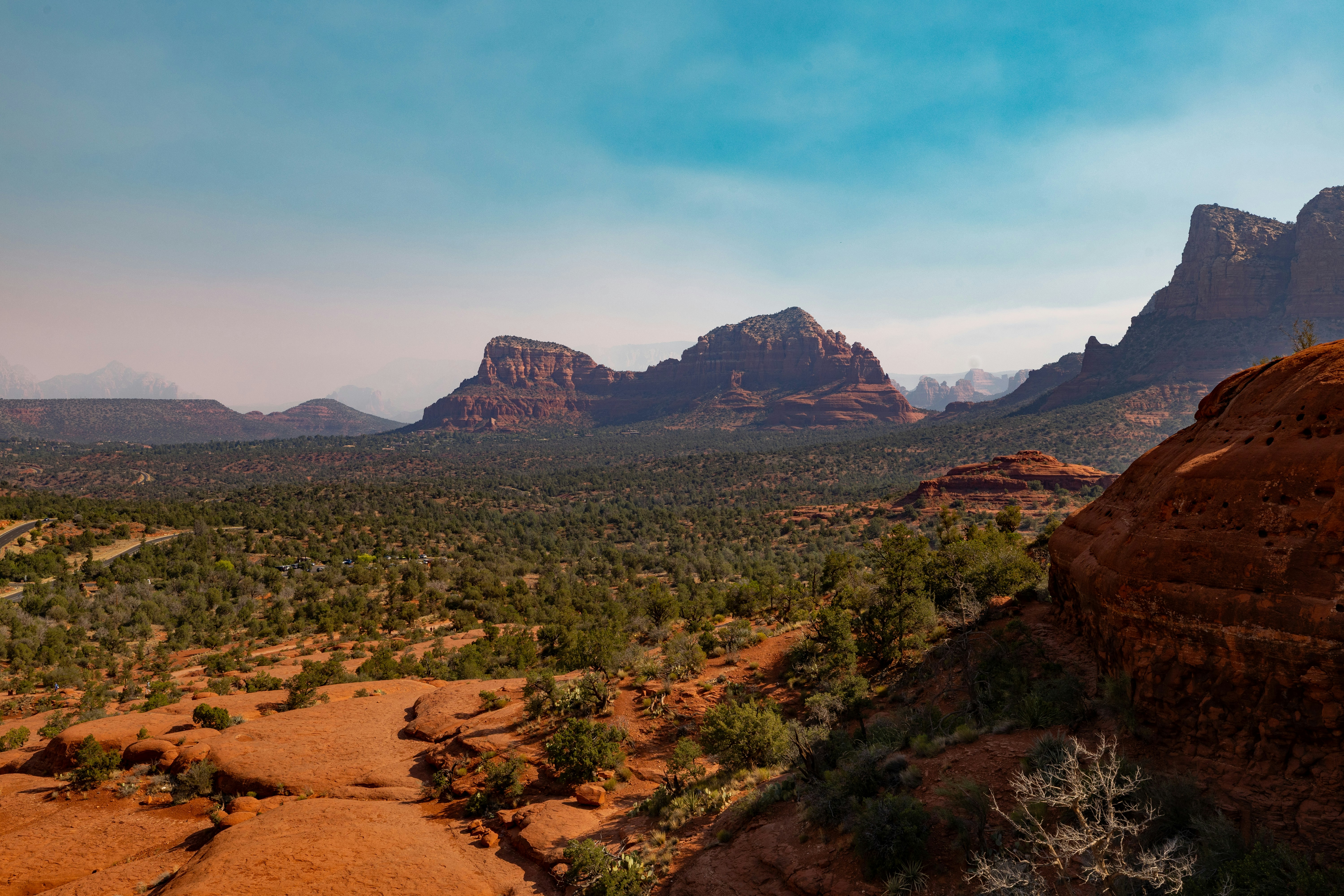 Desert Redscape: Erosion-Carved Cliffs under a Pale Sky