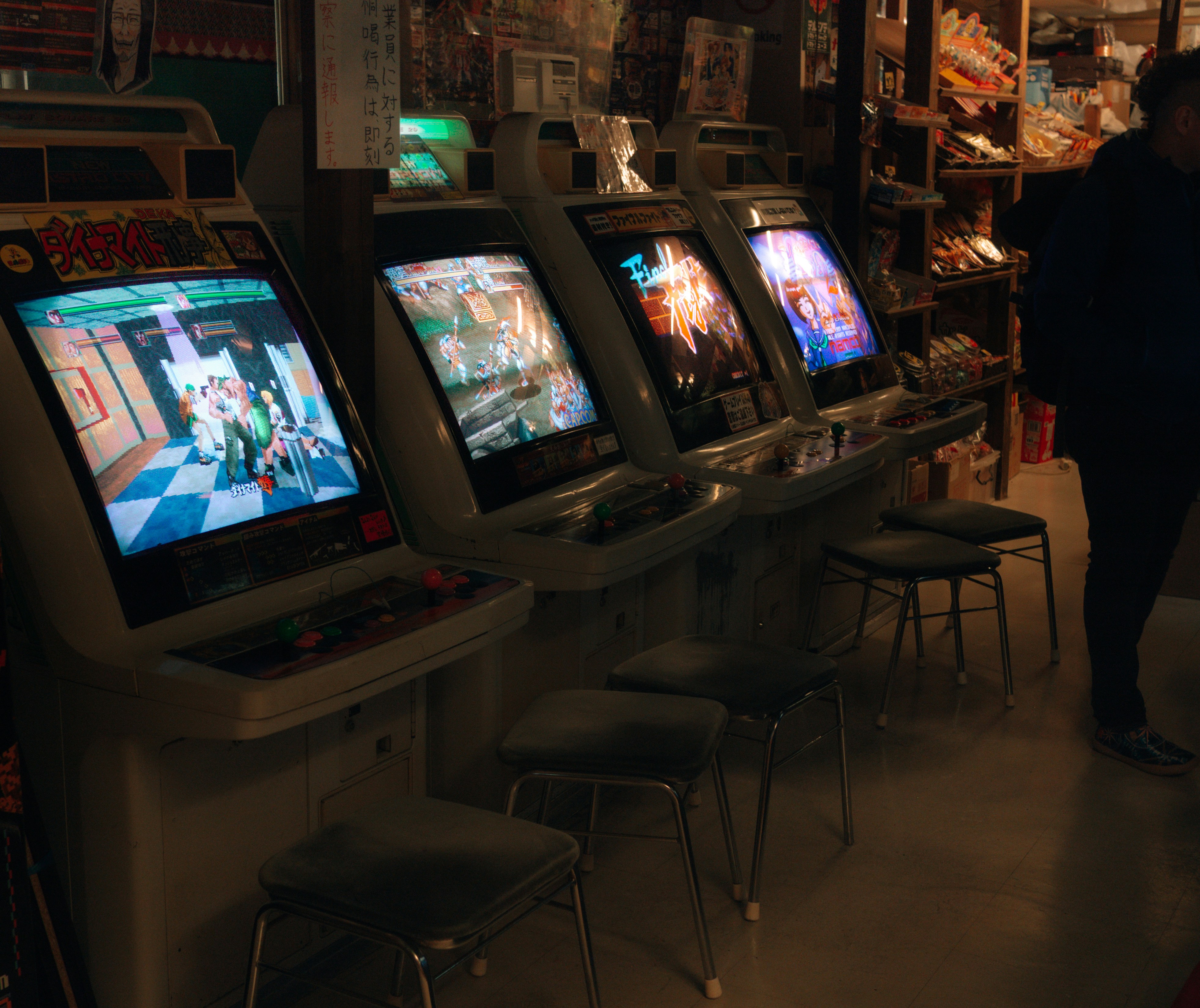 Arcade Alley: Rows of Neon Consoles in a Dim Shop