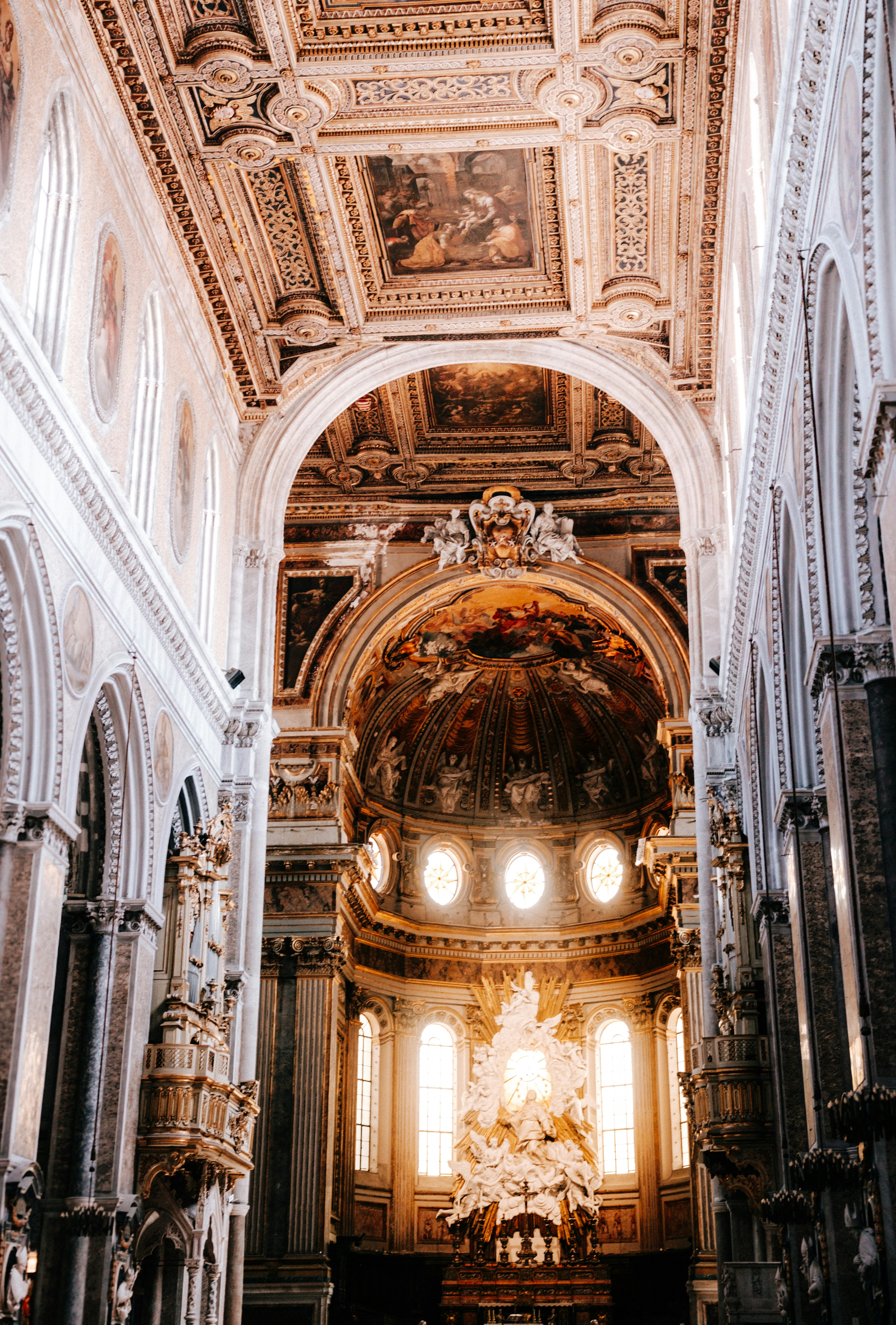 Vaulted Grandeur: Sunlit Nave and Baroque Dome