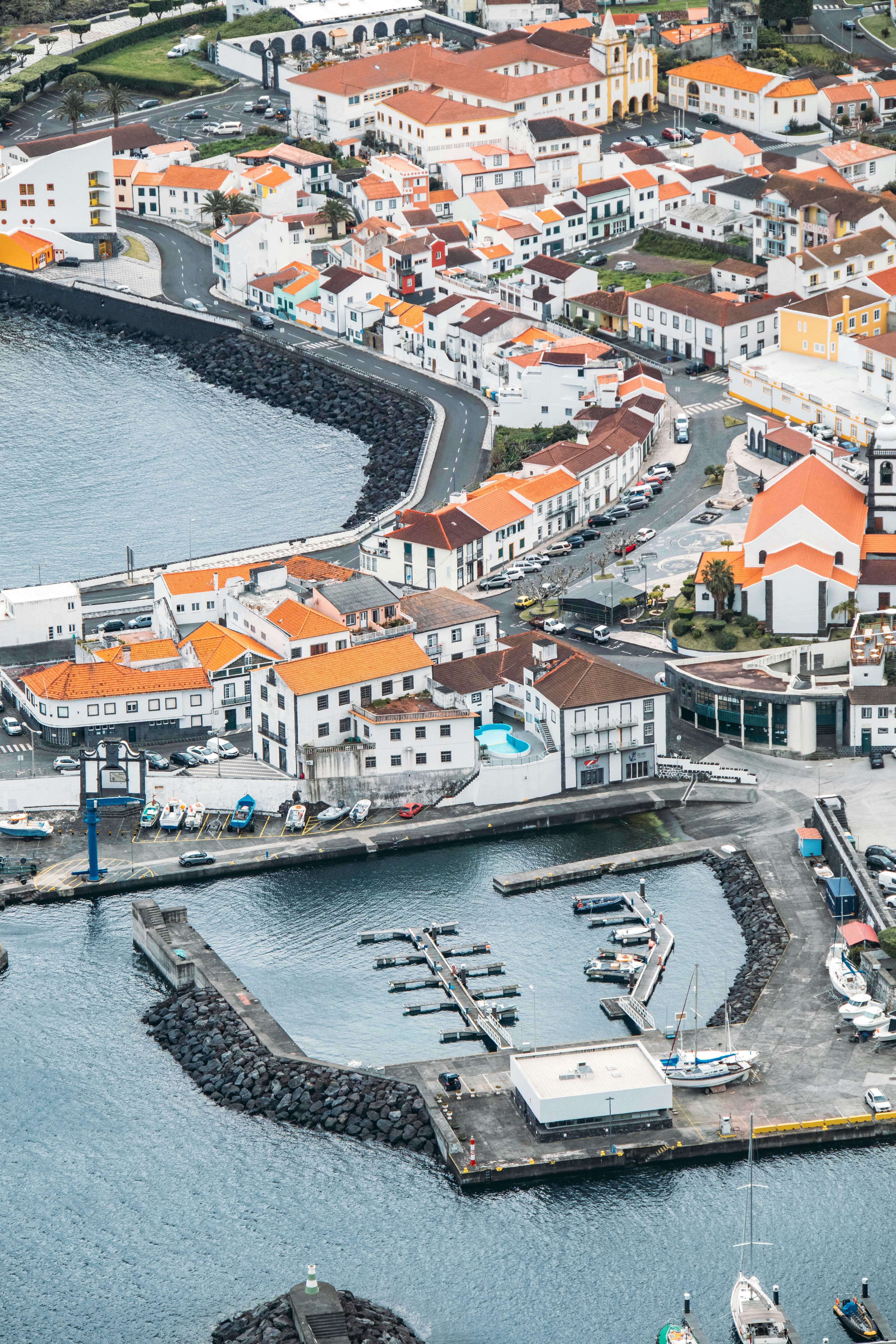 Harbor Village with Yellow-Orange Rooftops along a Curved Promenade