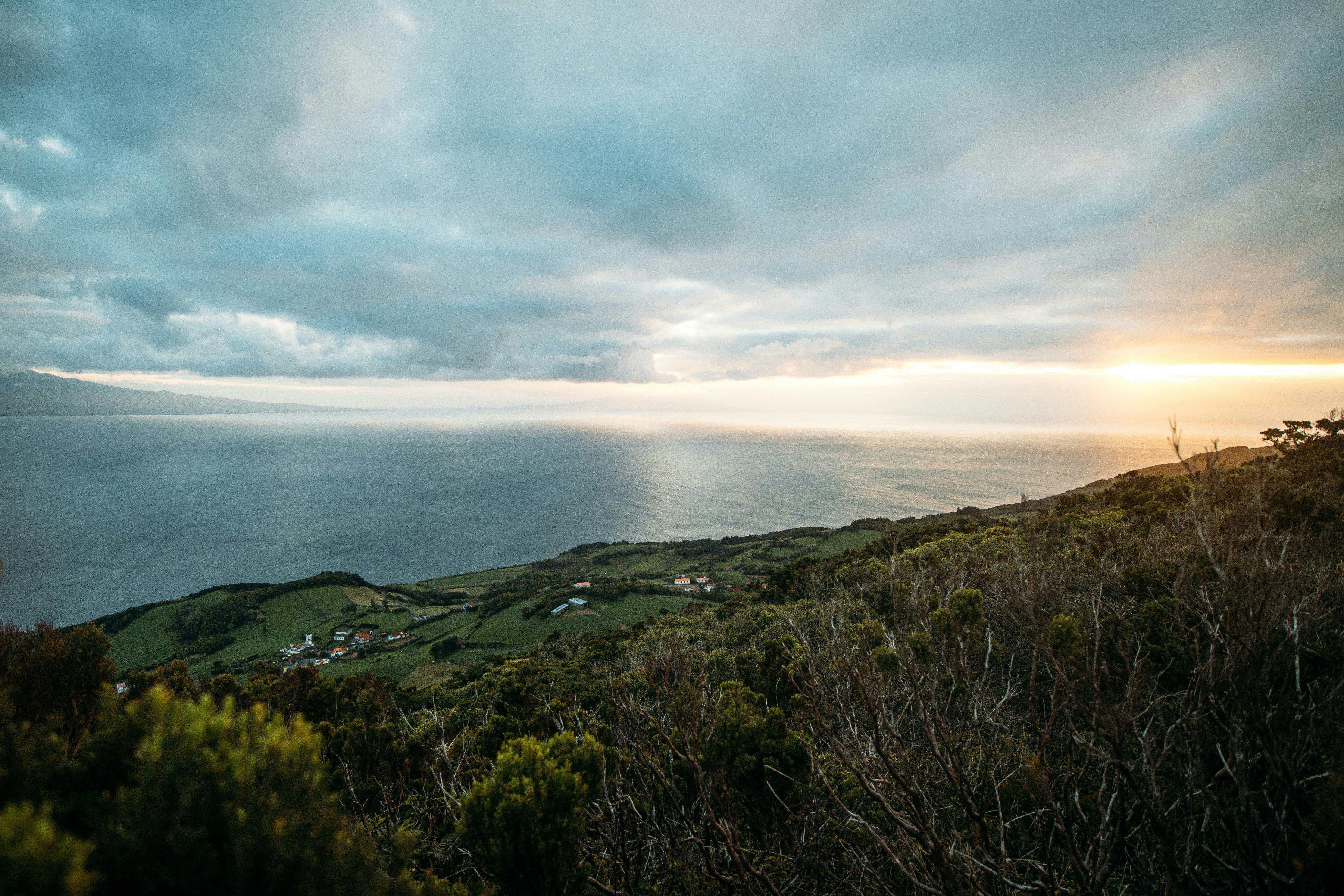 Sunrise over rolling coastline and hills