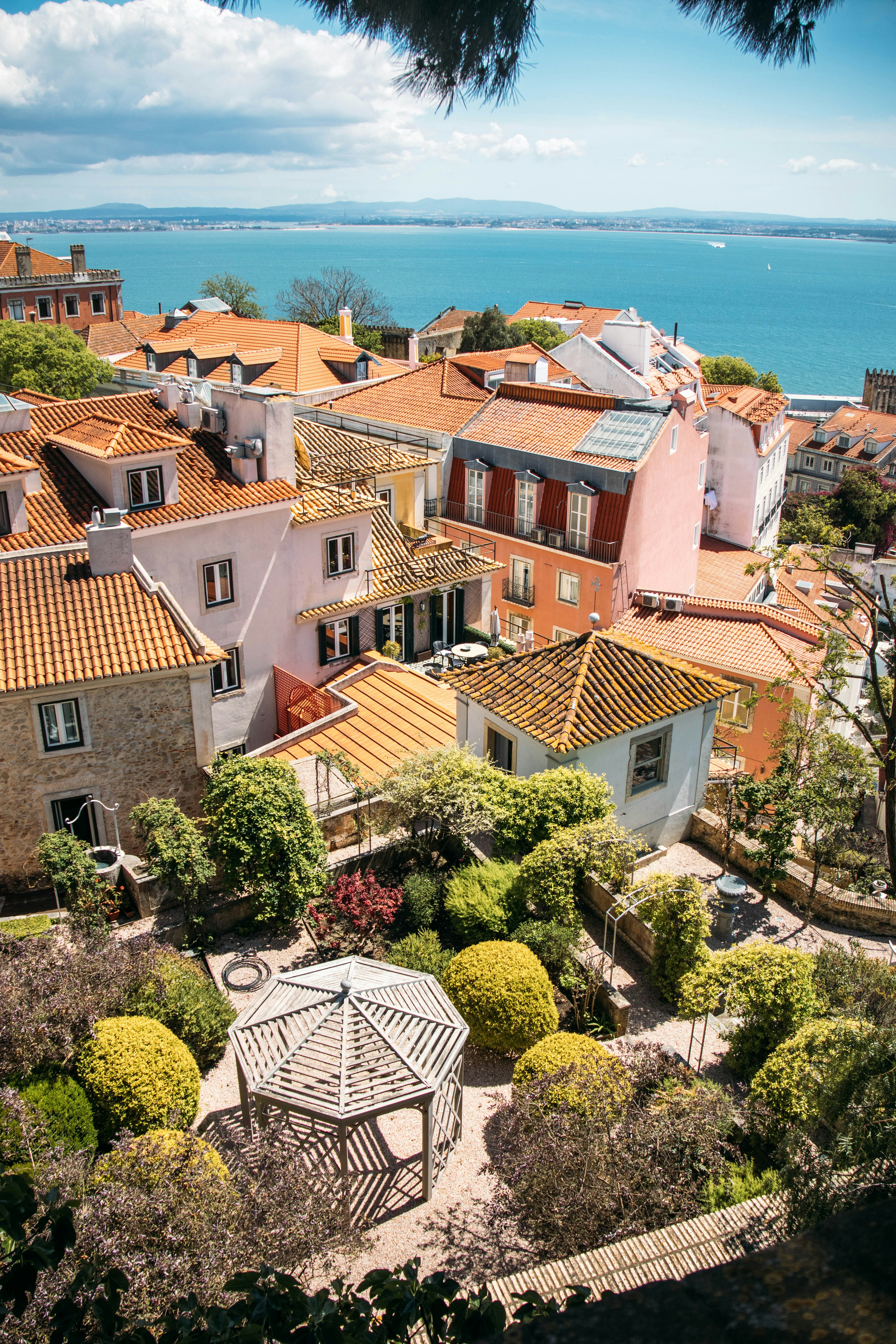 Sunlit Terracotta: A Vivid Coastal Village Nestled Between Rooftiles and Sea