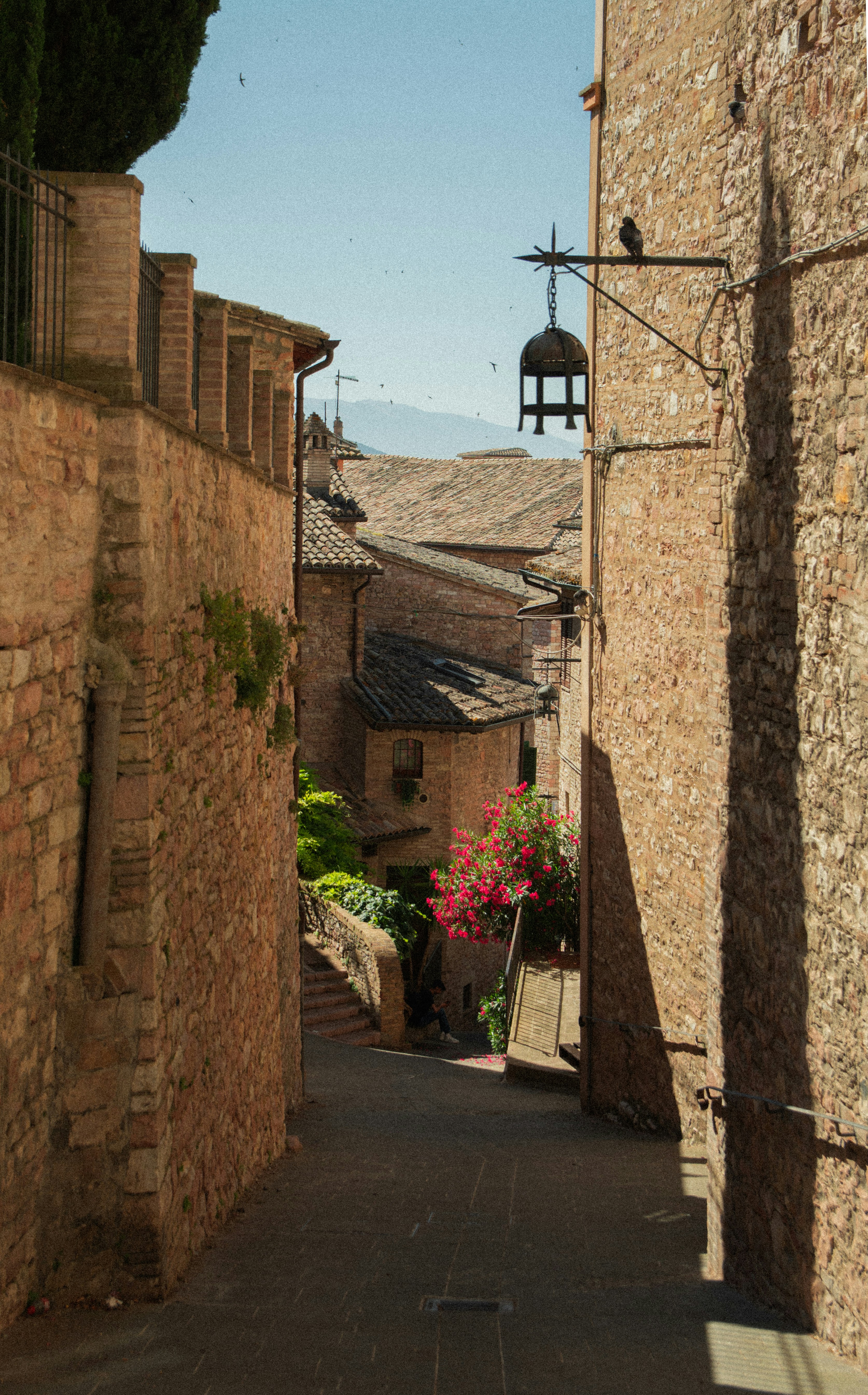 Sunlit Alleyway Through Time-worn Stone