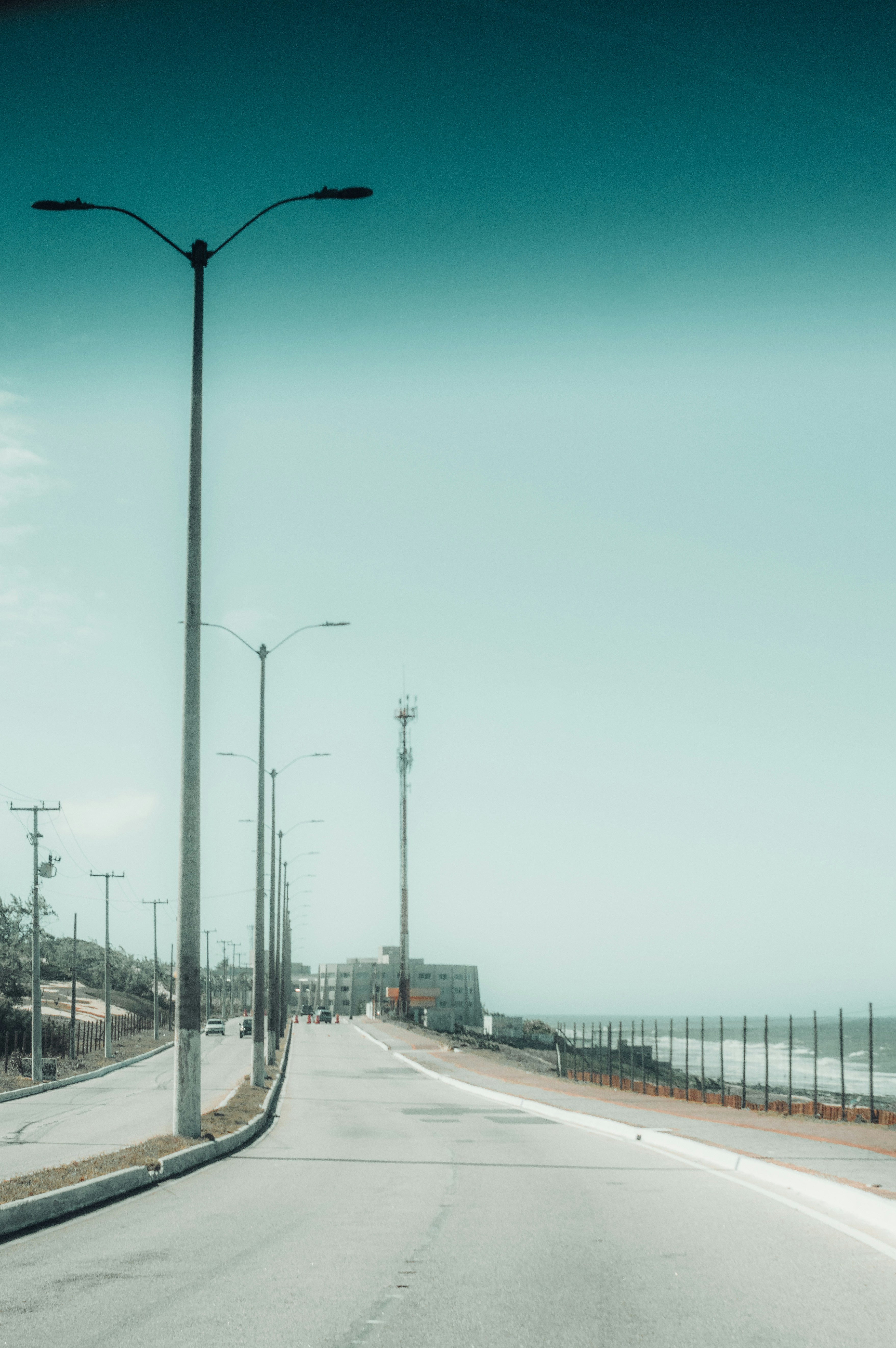 Coastal Avenue Fade: A Lighthouse of Street Lamps Along the Seaside Road