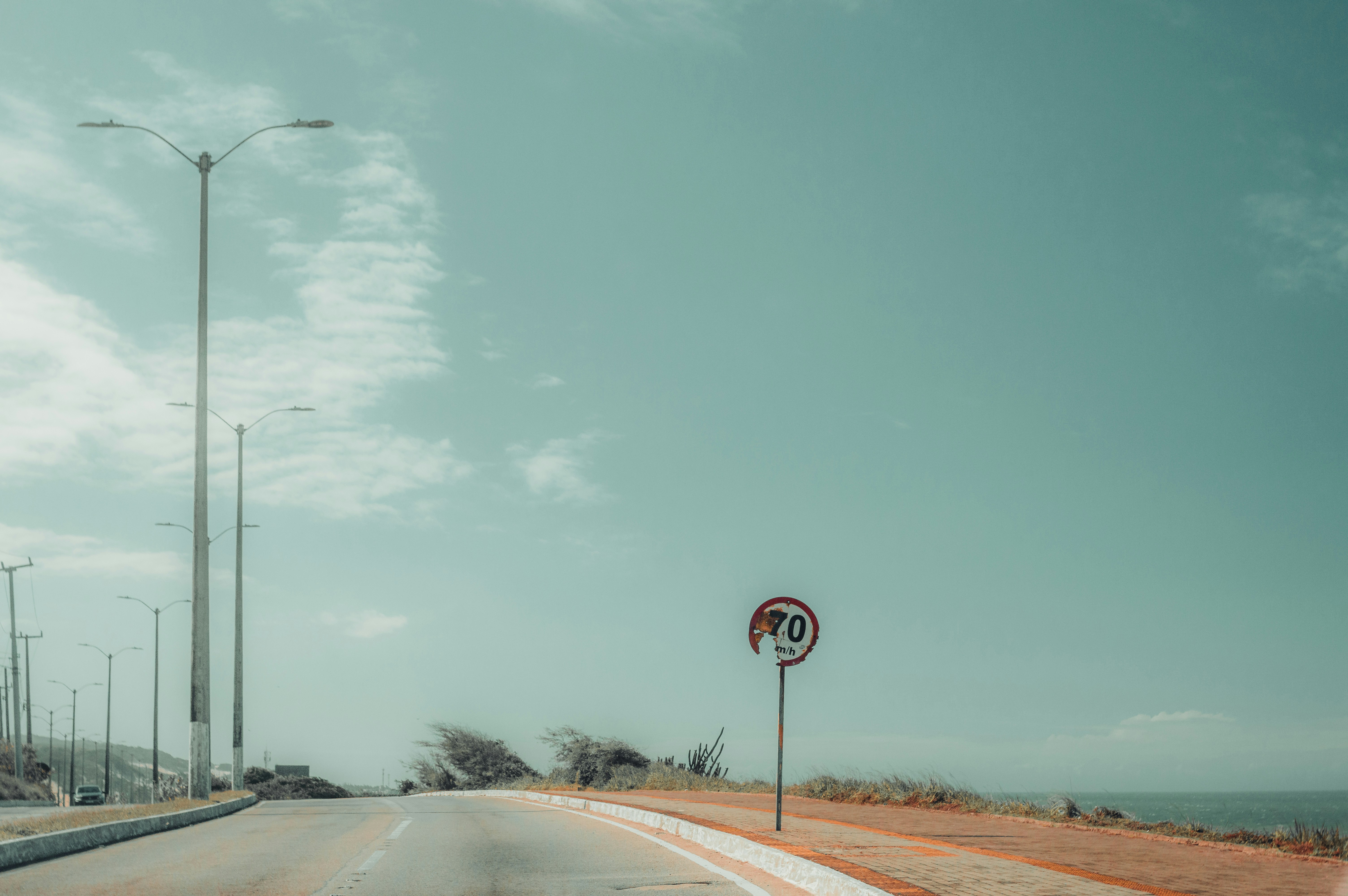 Road to the Sea: A Quiet Coastal Boulevard under a Pale Sky