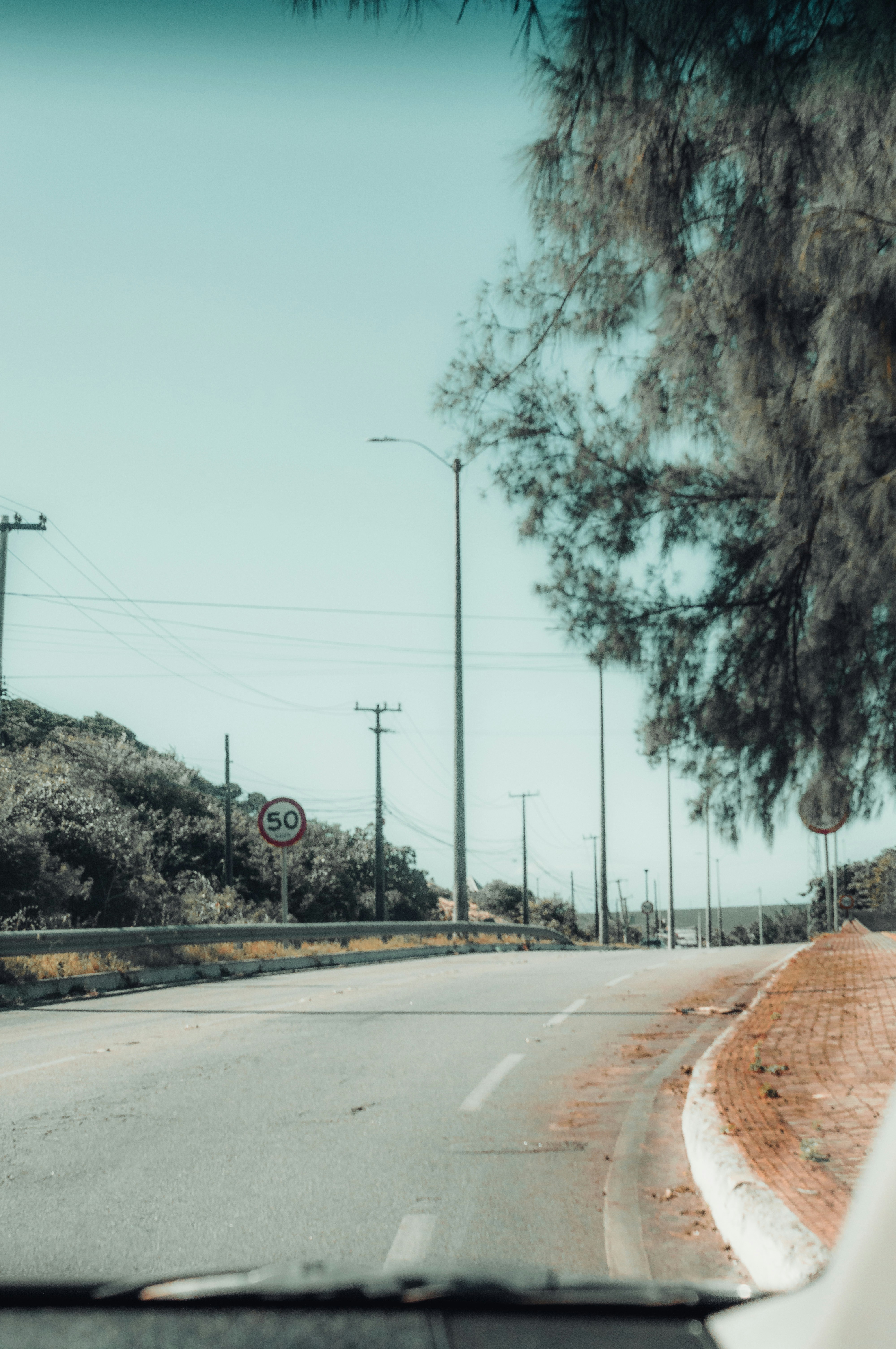 Deserted Coastal Road Looming Under Pale Sky