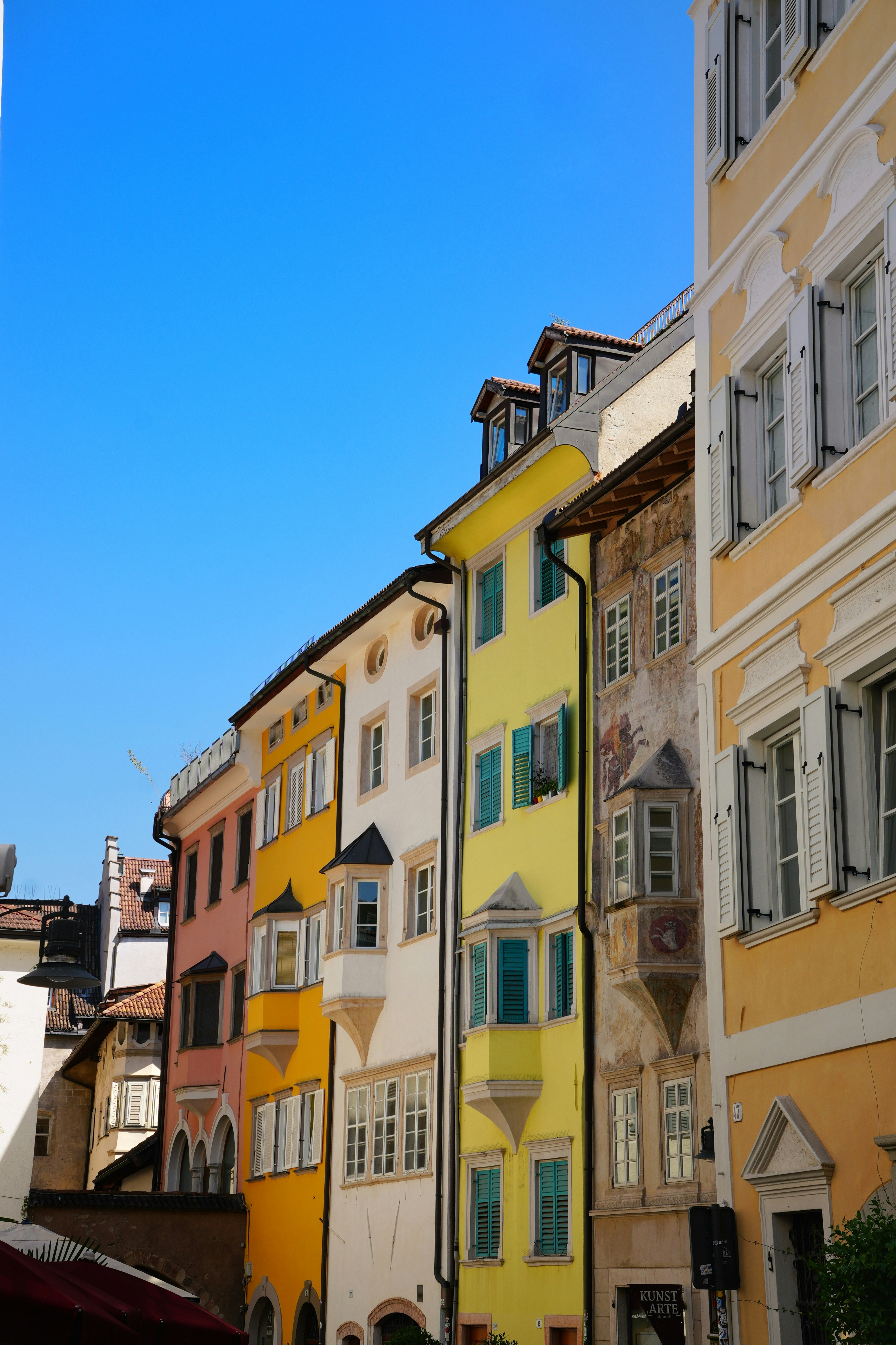 Sunlit Facades of a Woven Street