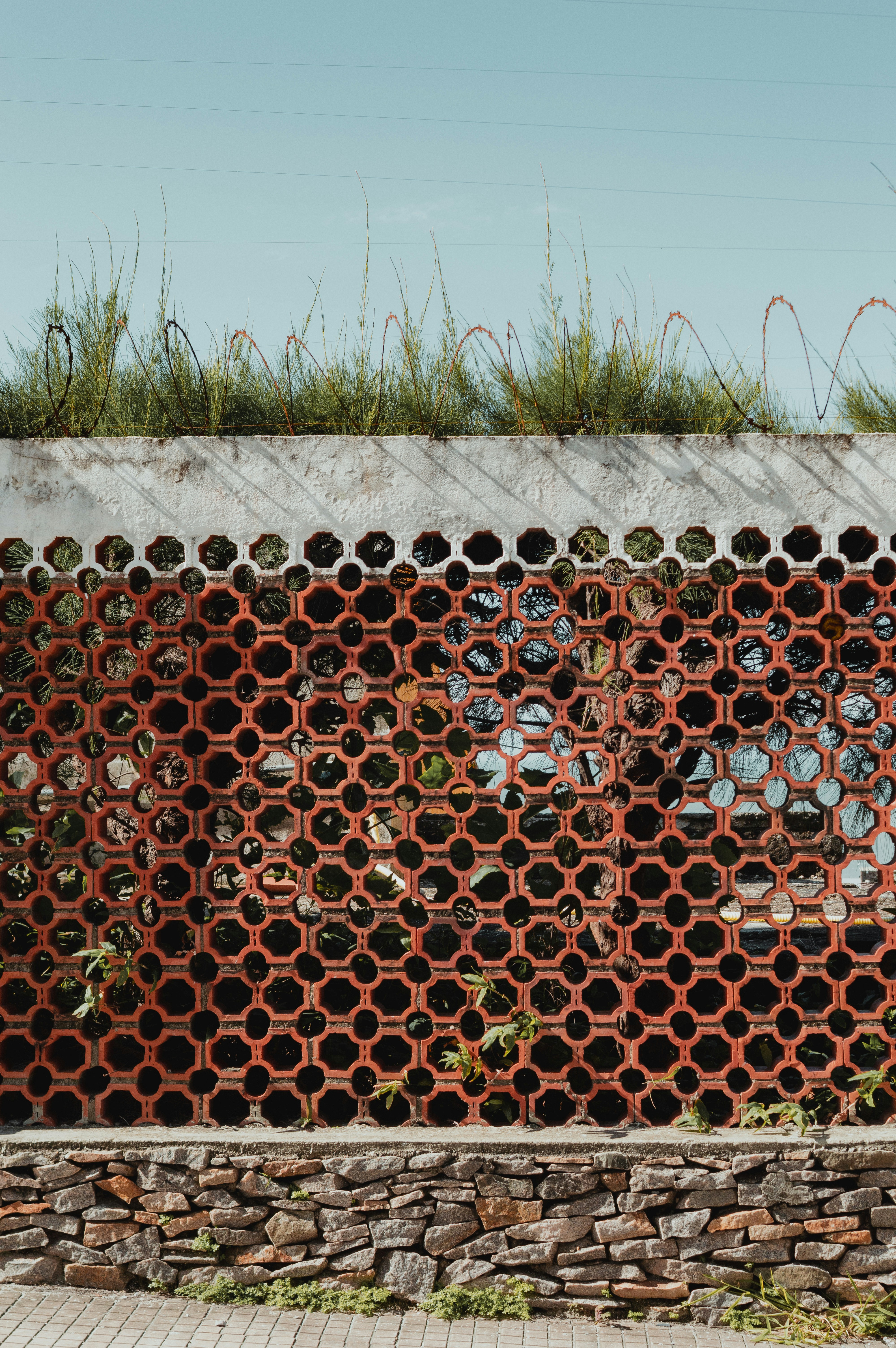 Red Geometric Screen over a Stone Baseline