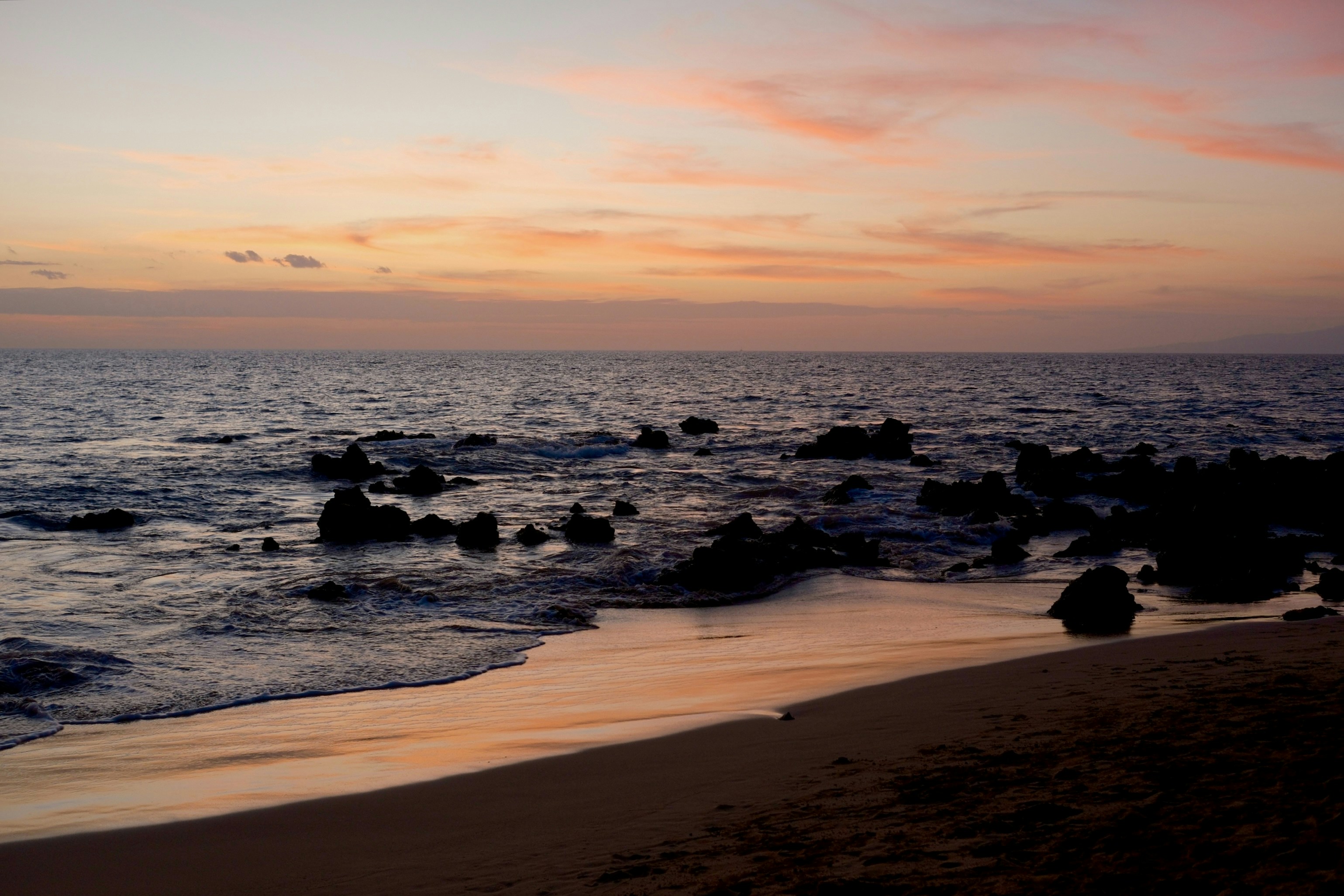 Horizon Glow: Evening Tide at a Rocky Shore